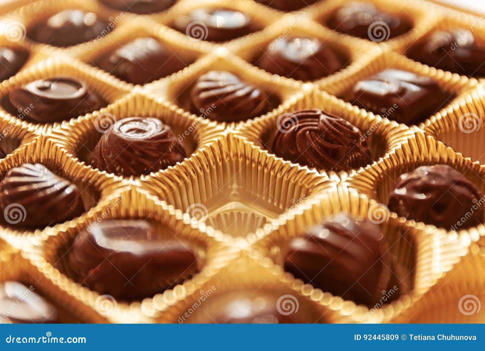 Chocolate Candies of Different Shapes in a Gold Box, a Perspective View ...
