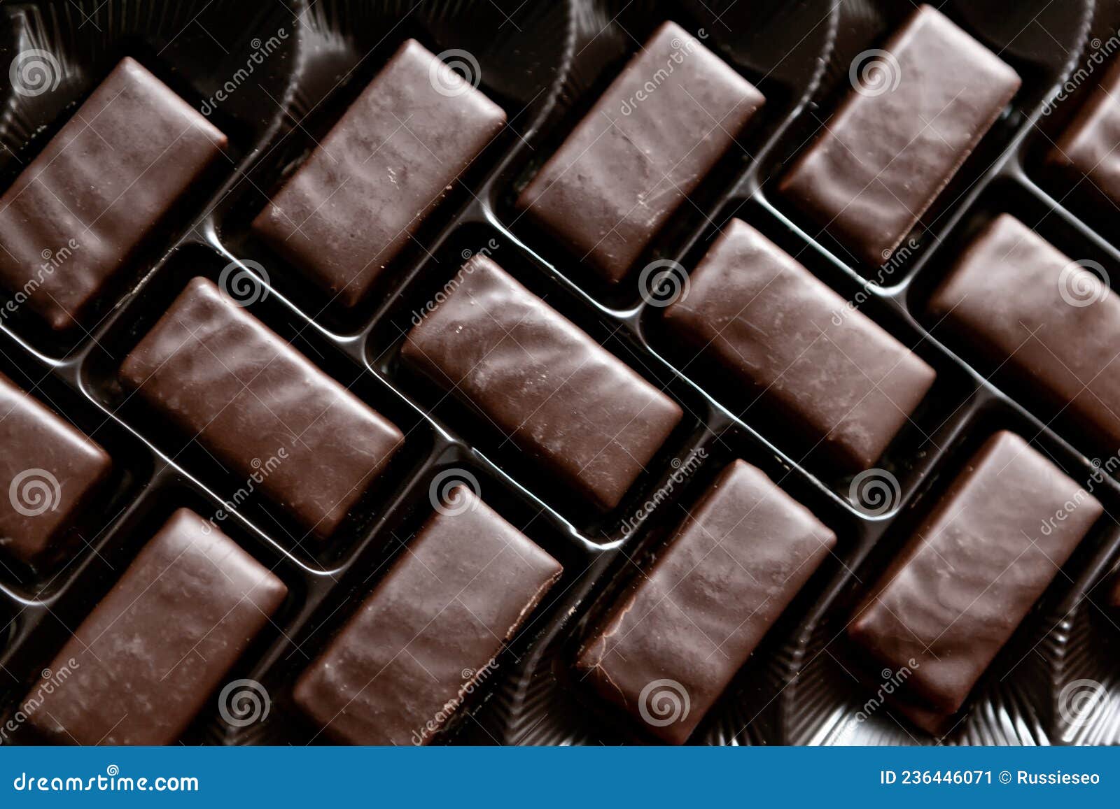 Chocolate candies in a row stock image. Image of confectionery - 236446071