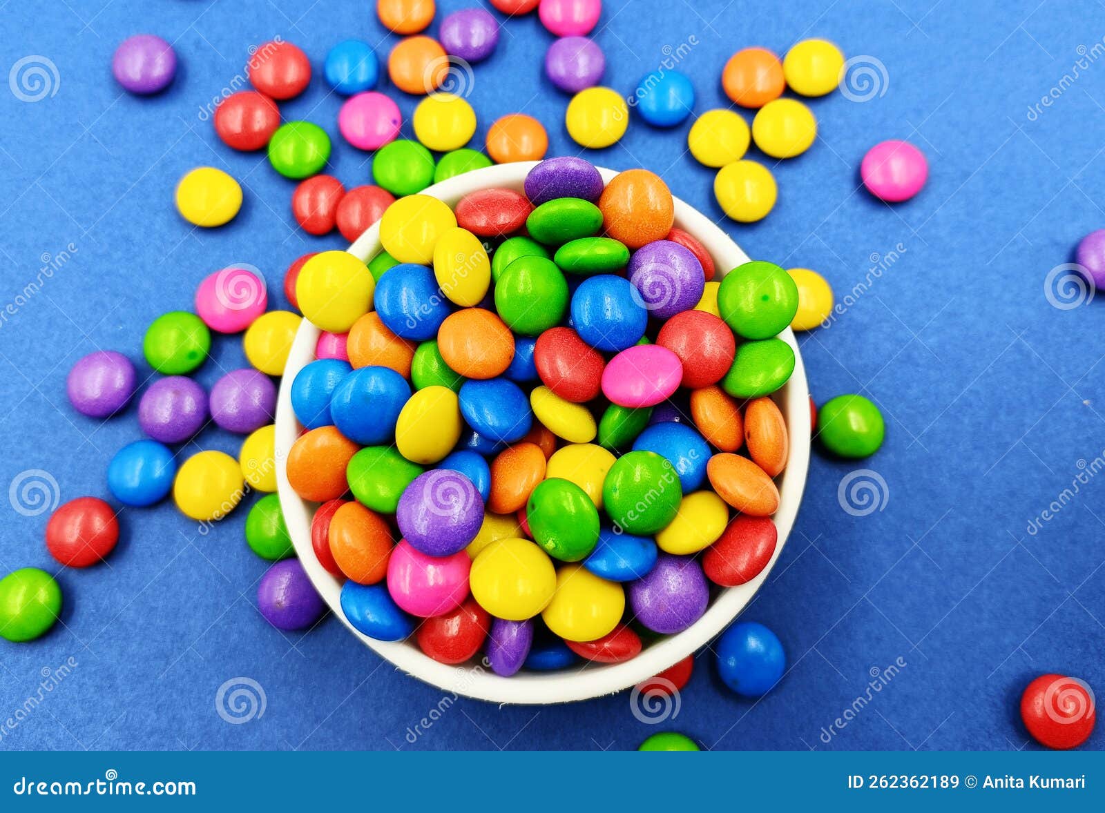 Chocolate Candy Gems on Blue Stock Image - Image of yellow, candy ...