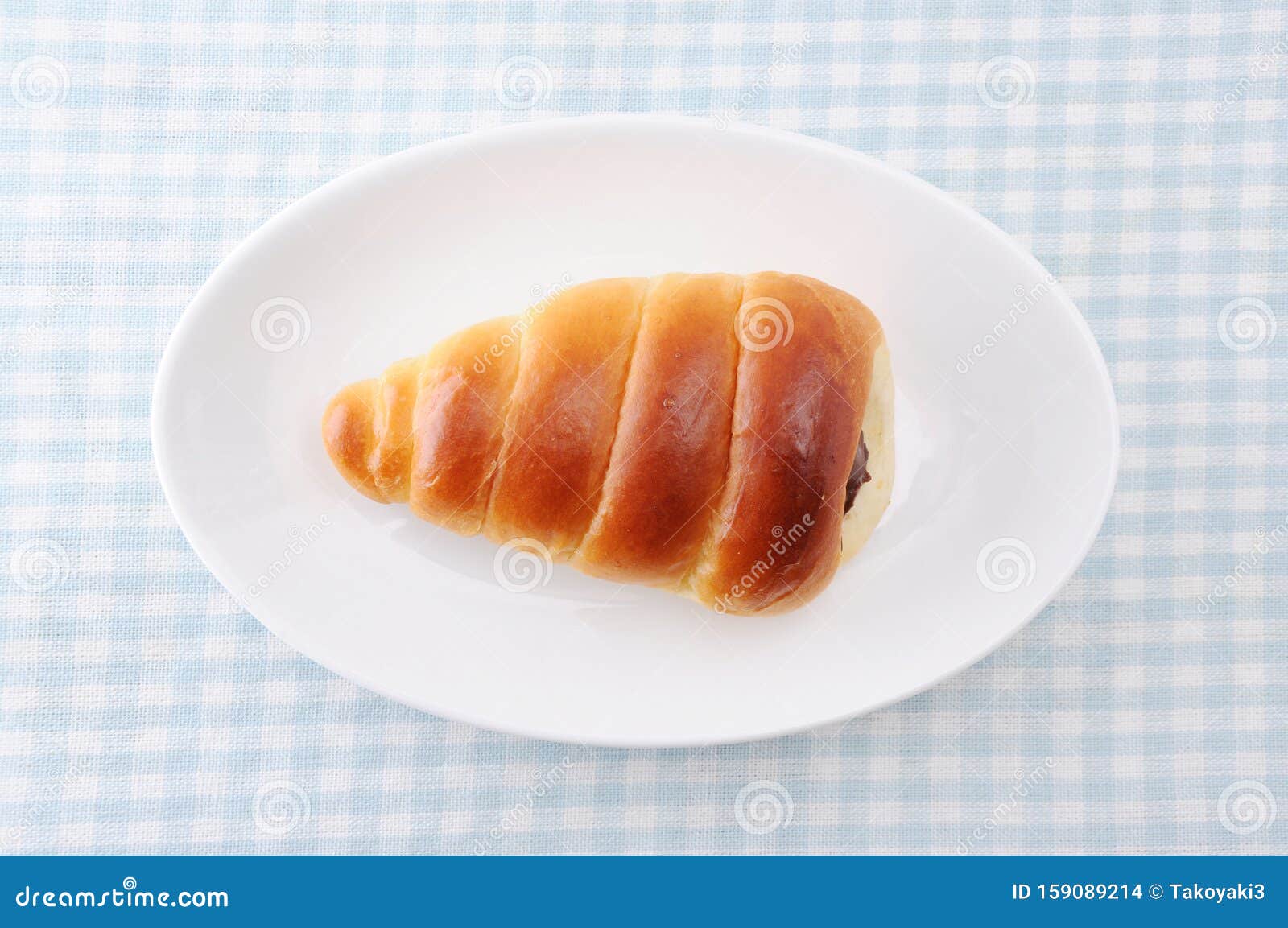 Chocolate Cornet Butter Bread Roll on a Plate on Table Cloth Stock ...