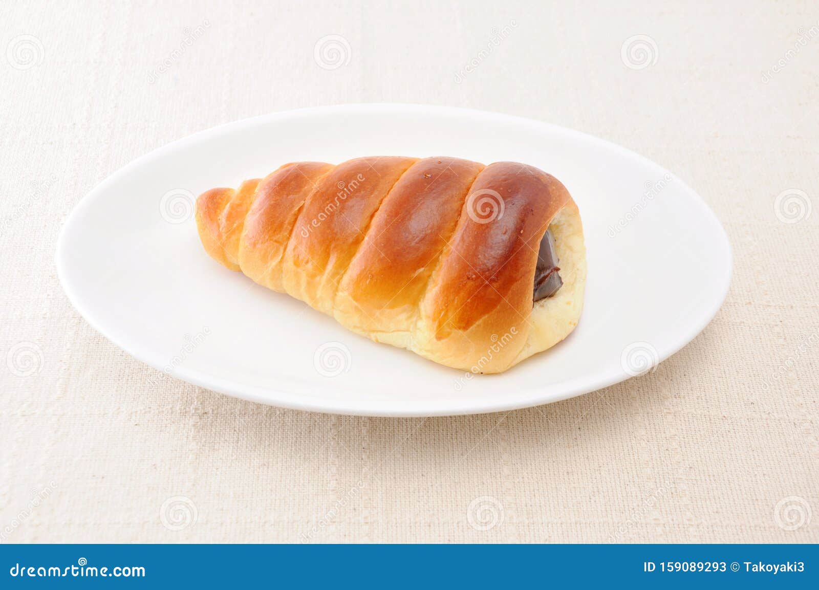 Chocolate Cornet Butter Bread Roll on a Plate on Table Cloth Stock ...