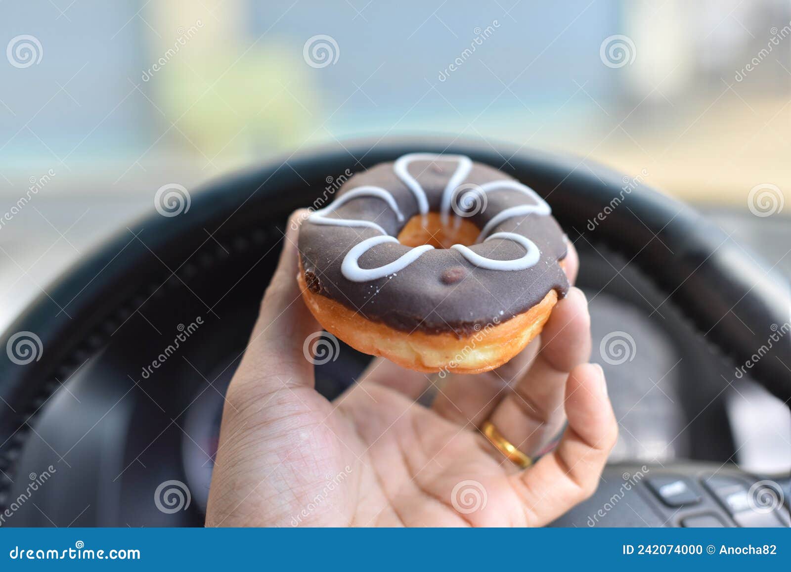 Chocolate Donuts in Hand in Car Driving Stock Photo - Image of donut ...