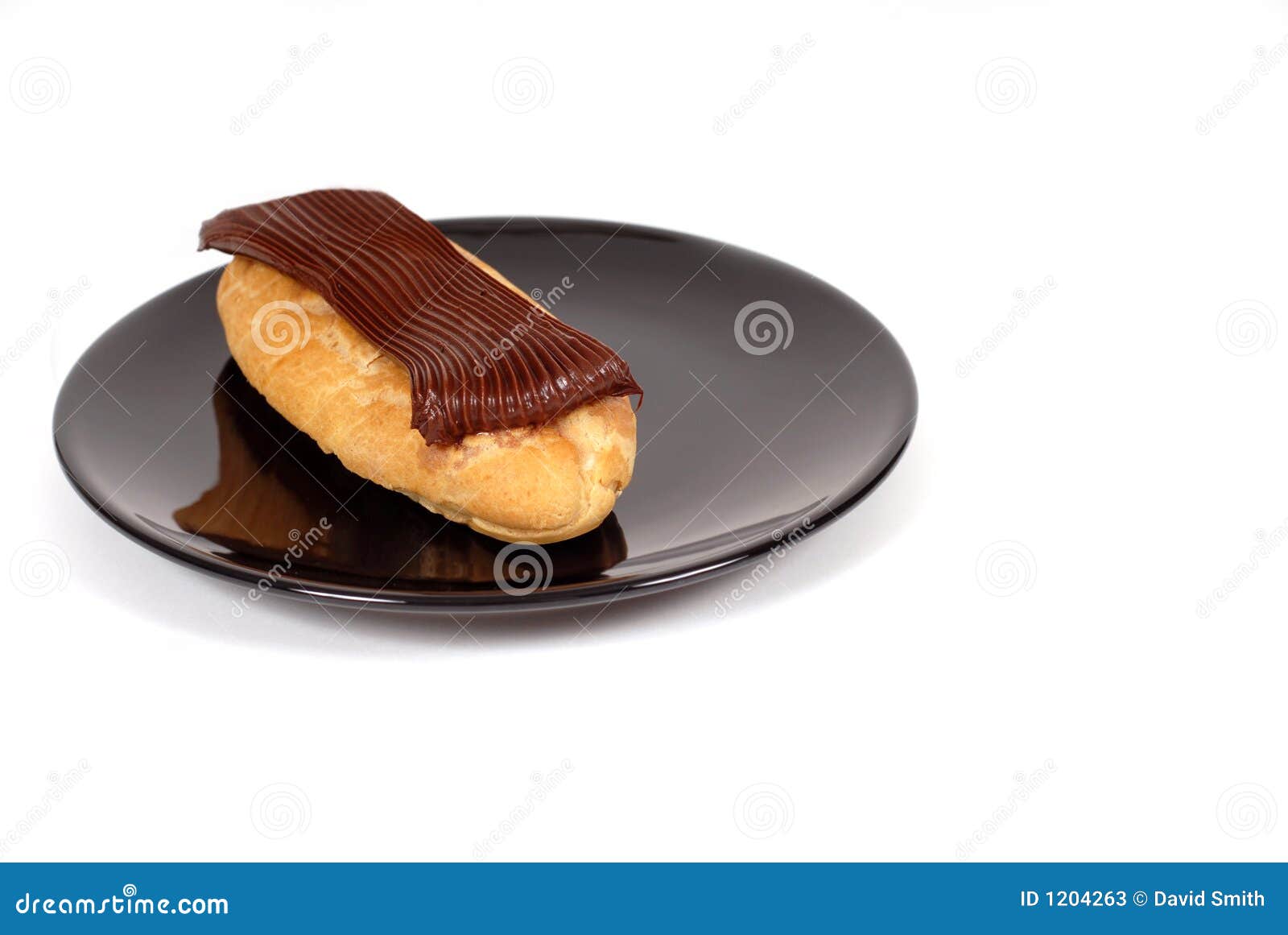 Chocolate Eclair on Black Plate Stock Image - Image of calories ...