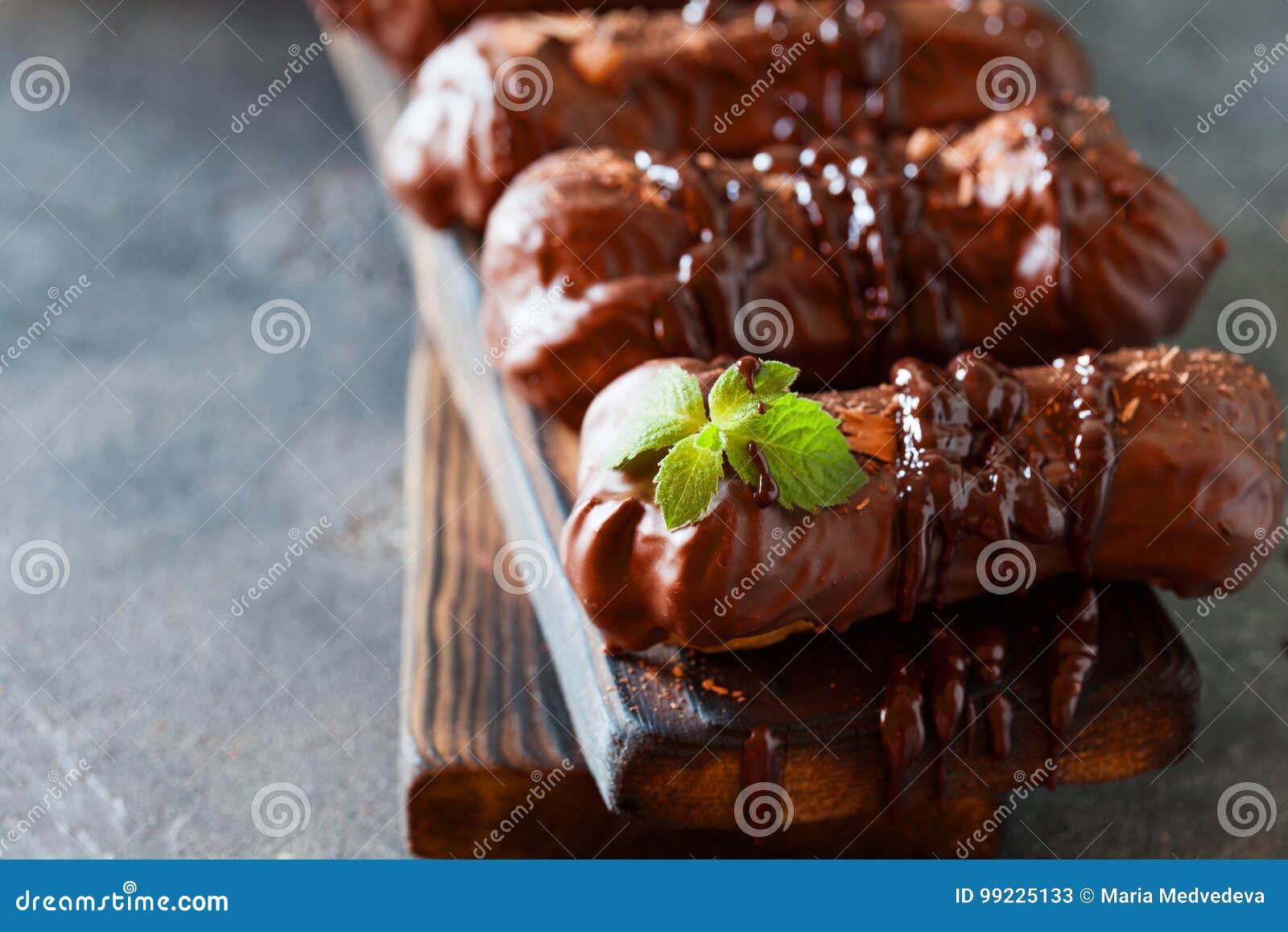 Chocolate Eclair Decorated with Mint and Melted Chocolate Stock Image ...