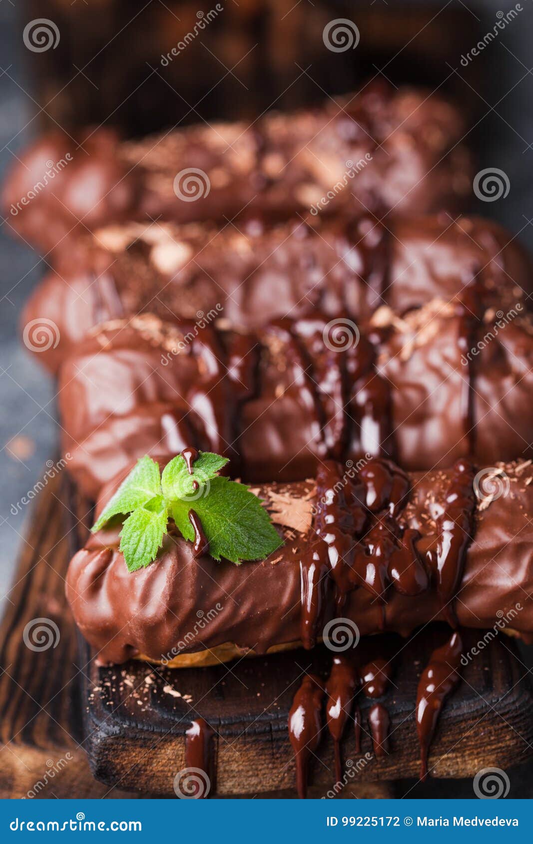 Chocolate Eclair Decorated with Mint and Melted Chocolate Stock Photo ...