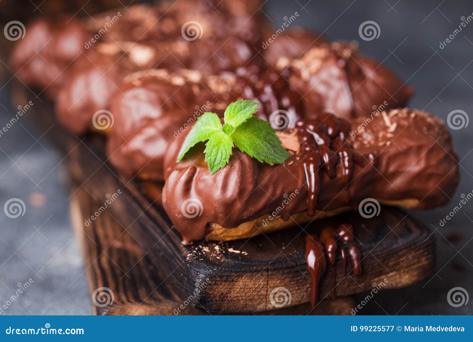 Chocolate Eclair Decorated with Mint and Melted Chocolate Stock Image ...