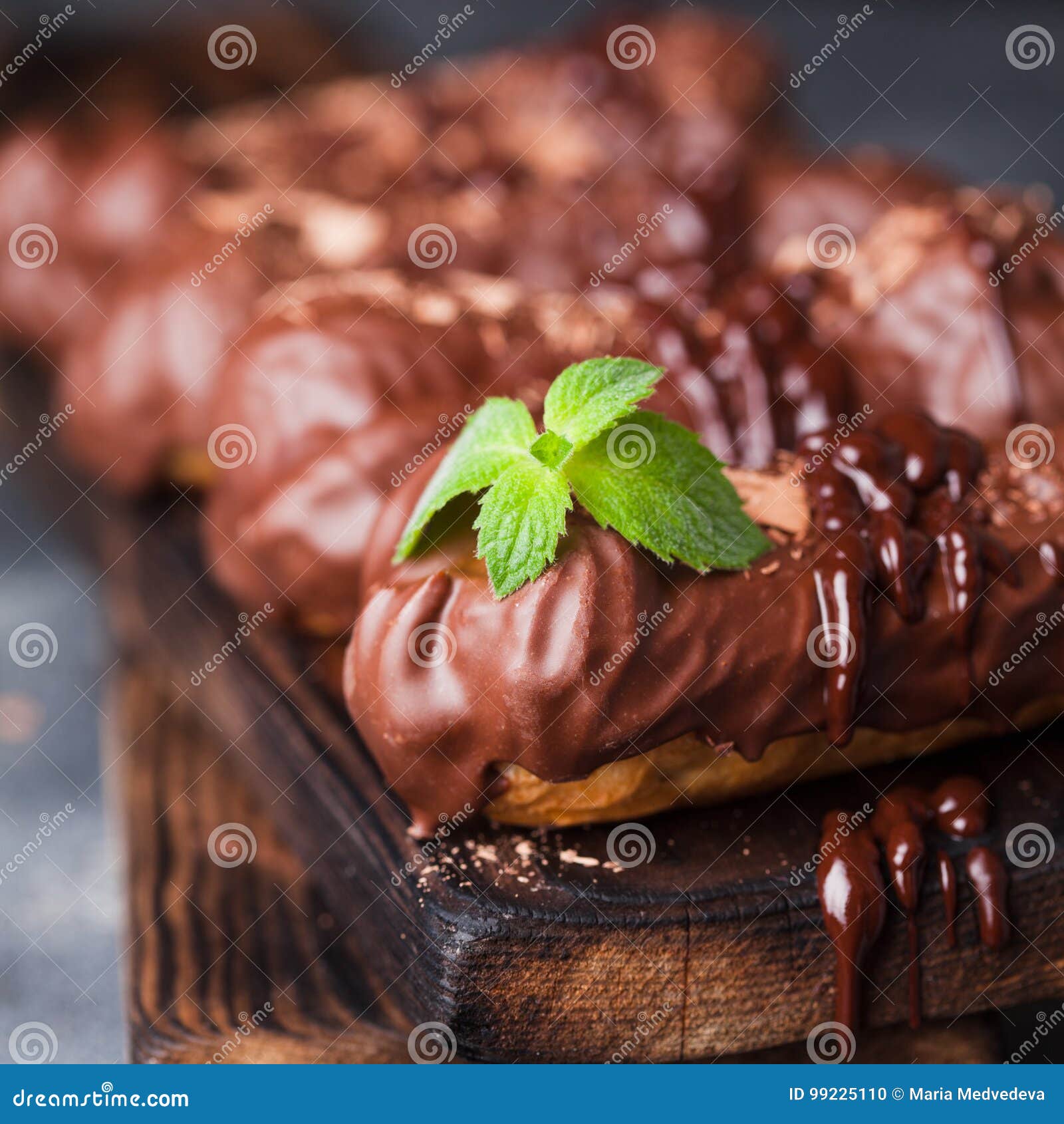 Chocolate Eclair Decorated with Mint and Melted Chocolate Stock Photo ...