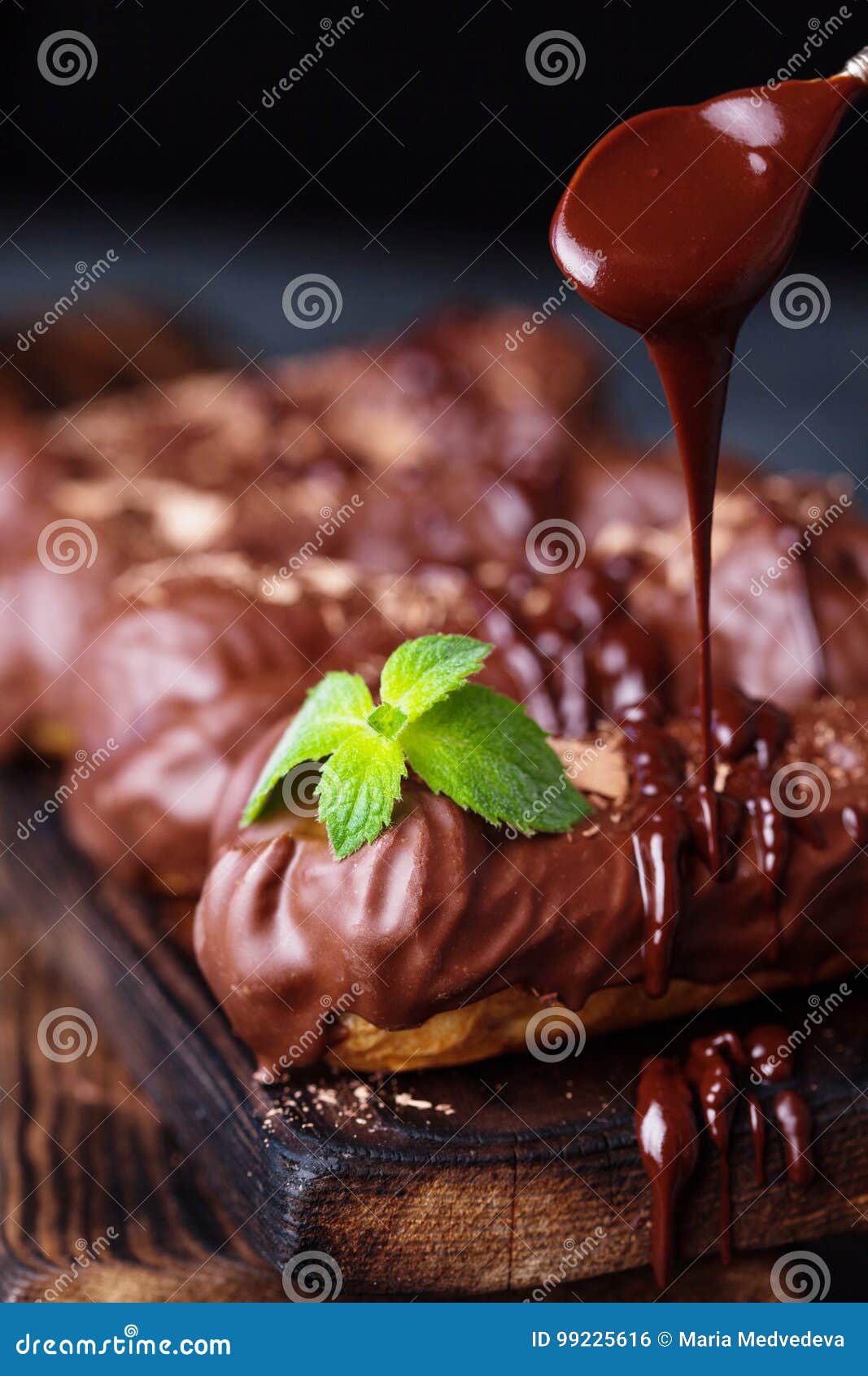 Chocolate Eclair Decorated with Mint and Melted Chocolate Stock Photo ...