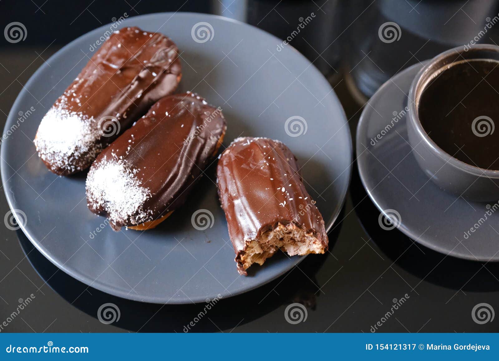 Chocolate Eclairs on a Plate and Cup of Coffee. Traditional Fcench ...