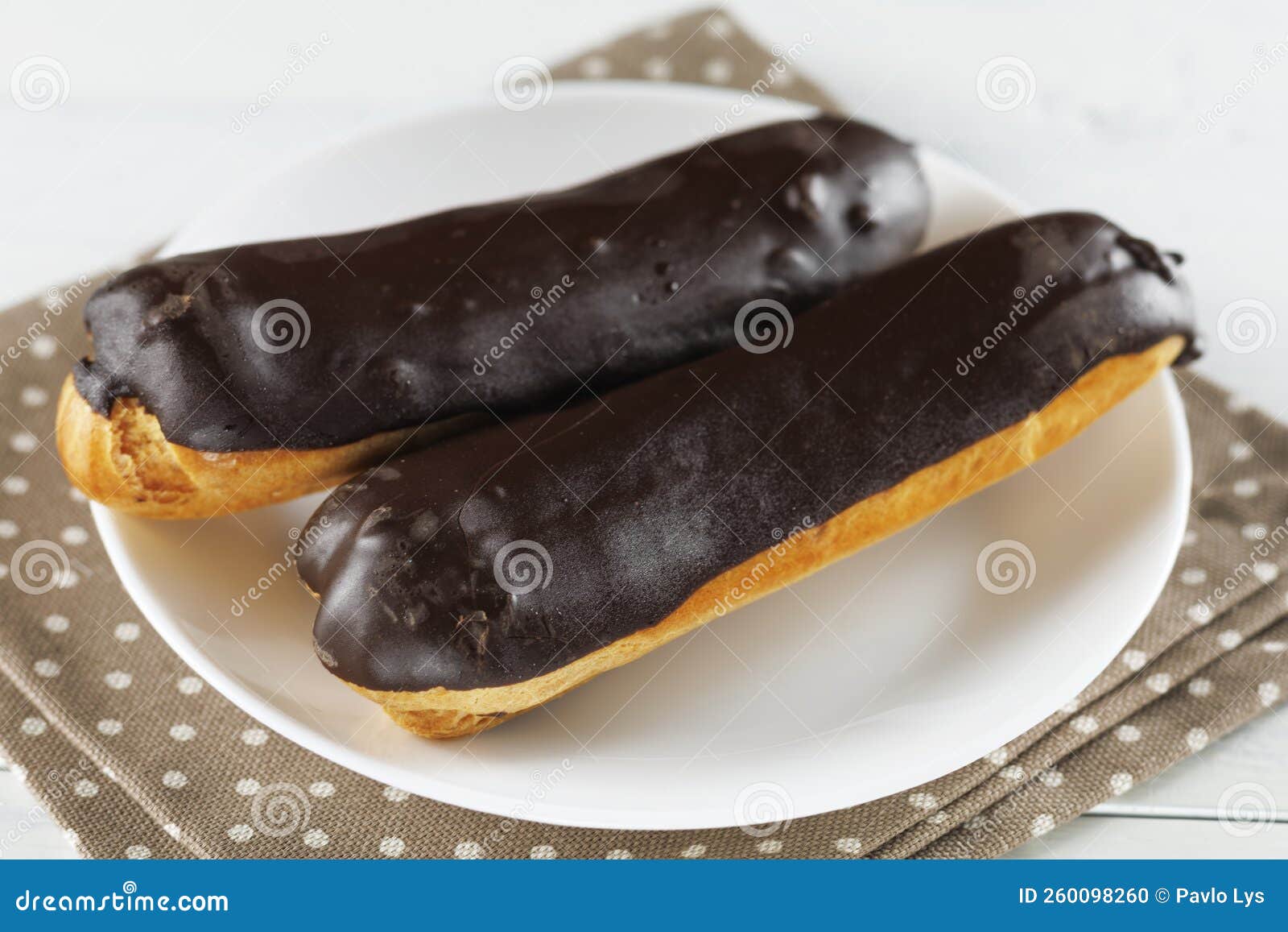 Chocolate Eclairs in a White Plate Close-up Stock Photo - Image of ...