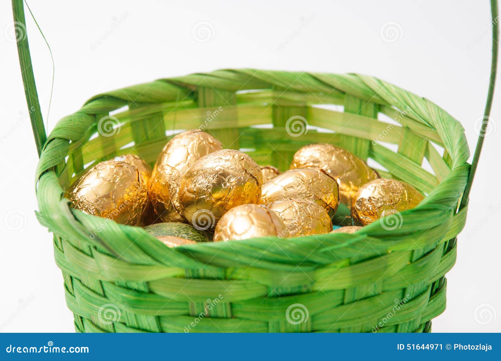 Chocolate Golden Easter Egg in Green Basket Stock Image - Image of ...