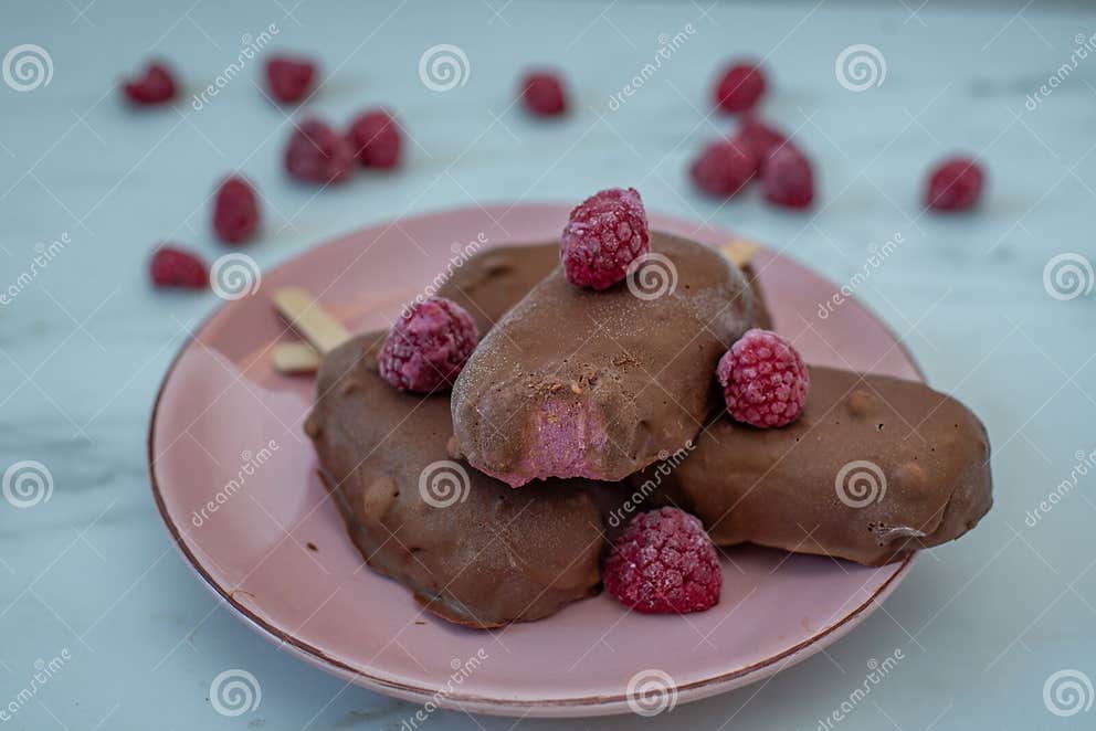 Chocolate Ice Cream on a Stick with Raspberries Stock Image - Image of ...