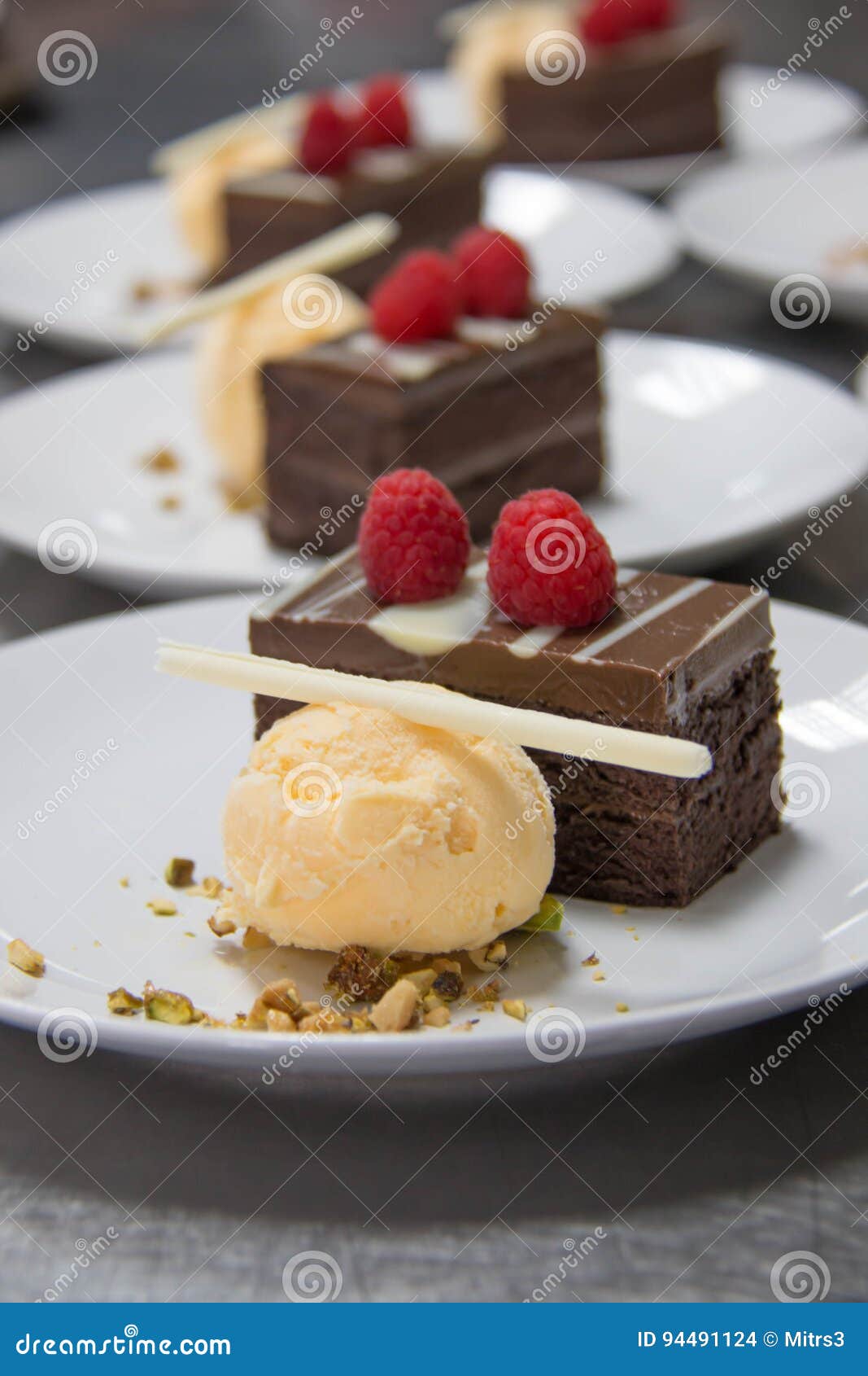 Chocolate Layered Cake Topped with Raspberry and Ice Cream Stock Photo ...