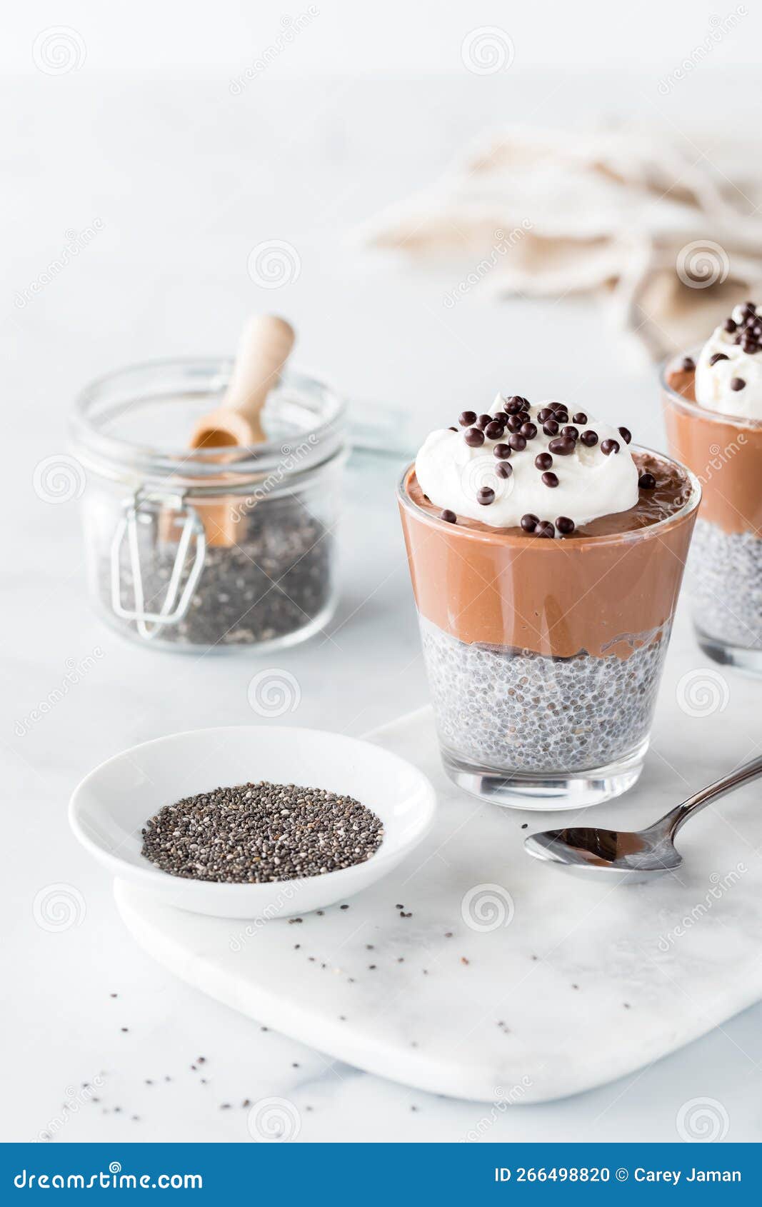 A Chocolate Mousse Chia Pudding with Chia Seeds in Front and To the ...