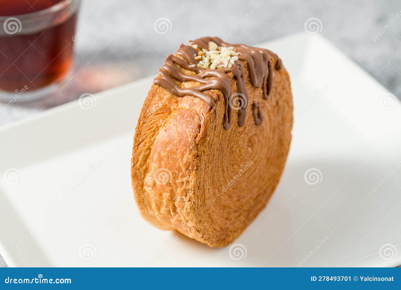 Chocolate New York Roll or Round Croissant with Tea on Stone Table ...
