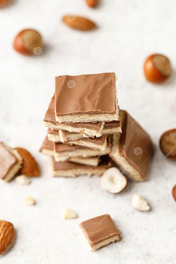 Chocolate Pieces on White Background with Hazelnut. Stack of Chocolate ...