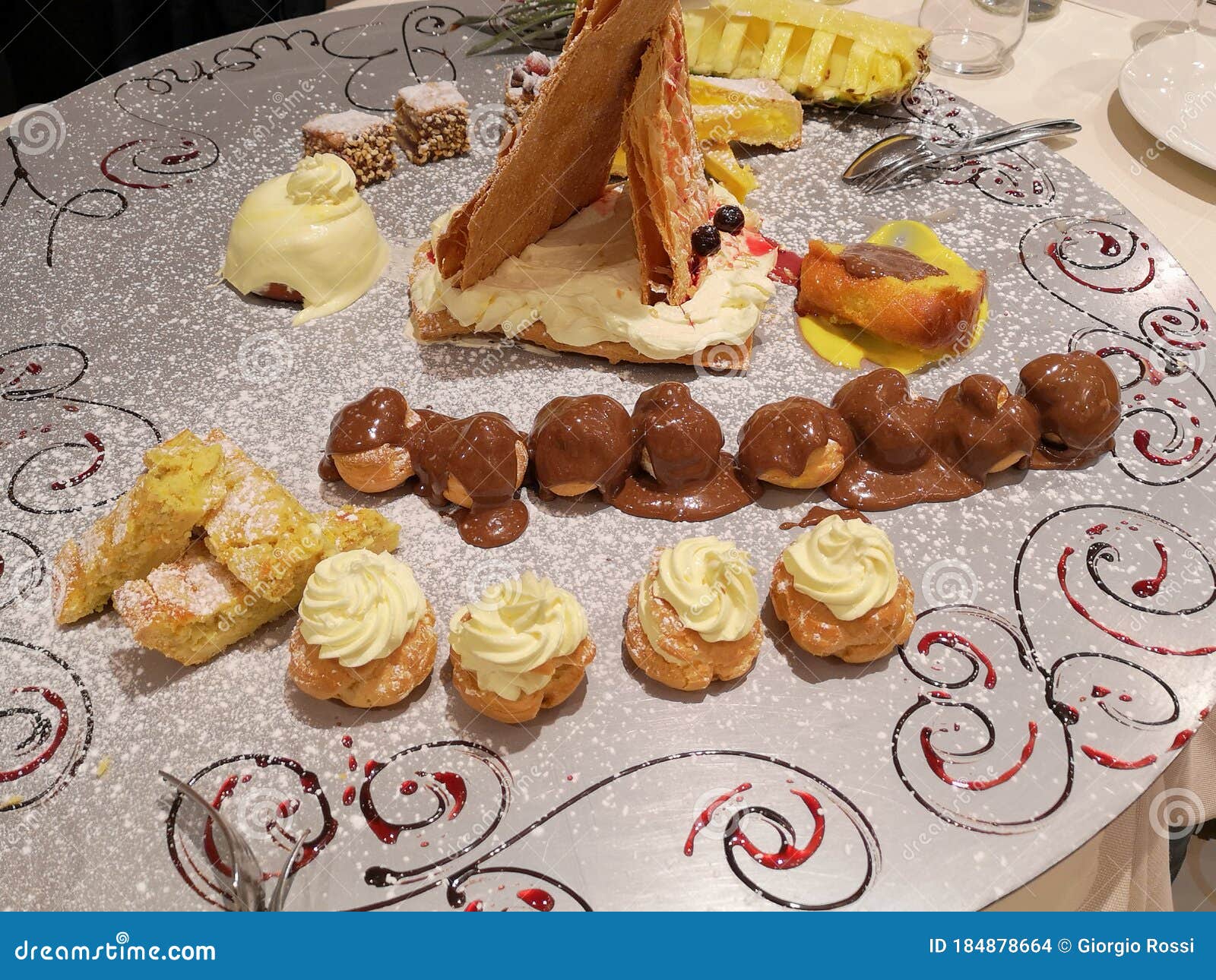 Chocolate Puffs, Cream Pastries and Various Sweets in a Large Tray of ...