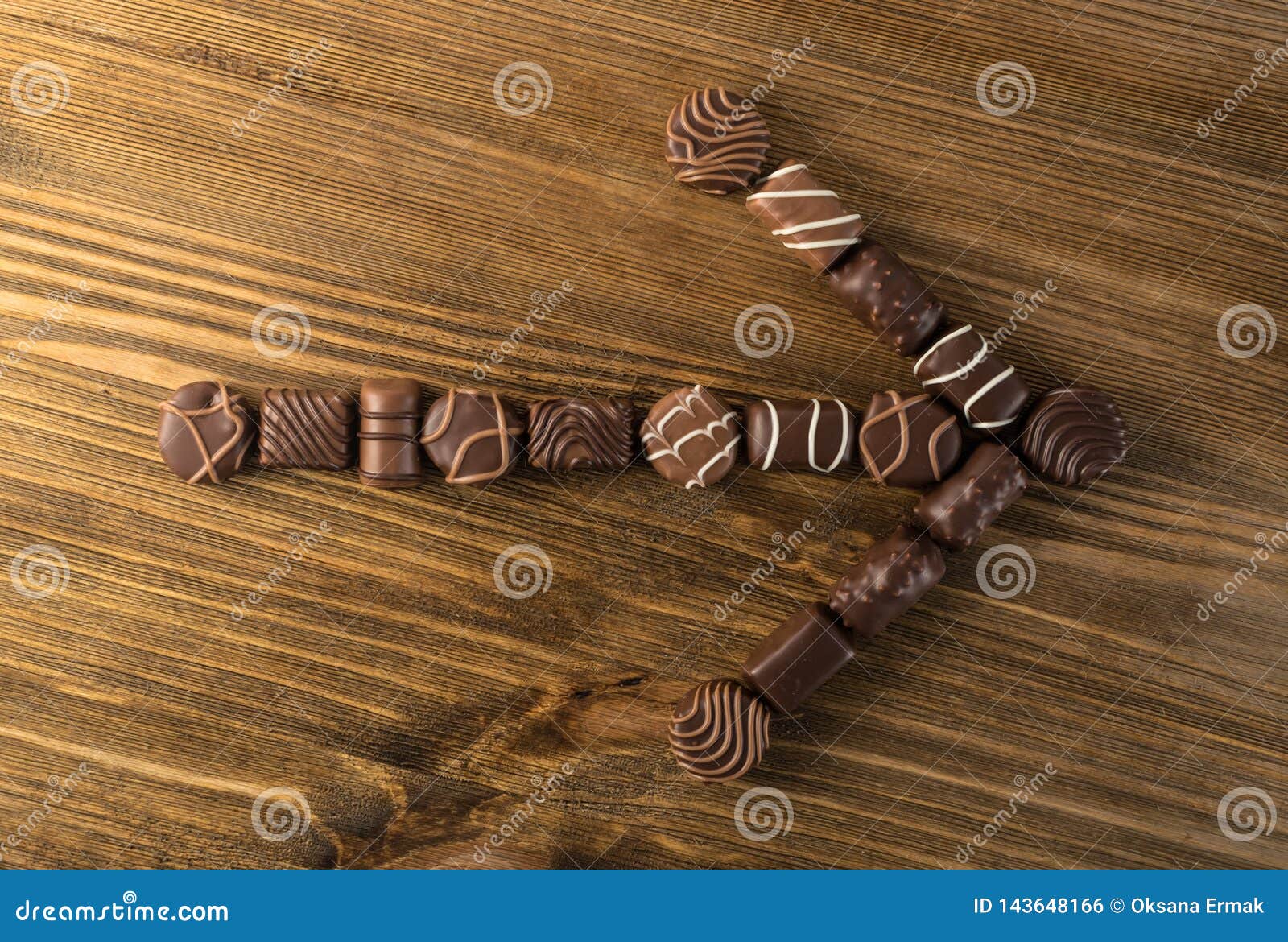Chocolate Sweets Arrow on Old Wooden Background Stock Photo - Image of ...
