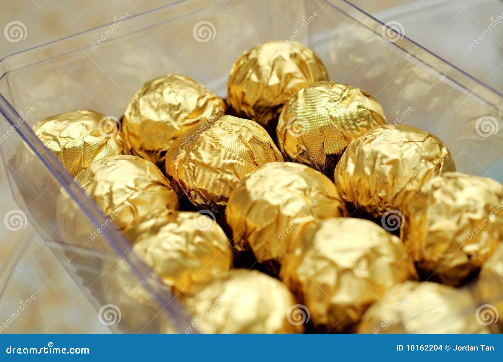Chocolate Wrapped in Gold Foils Stock Photo - Image of foil, gold: 10162204