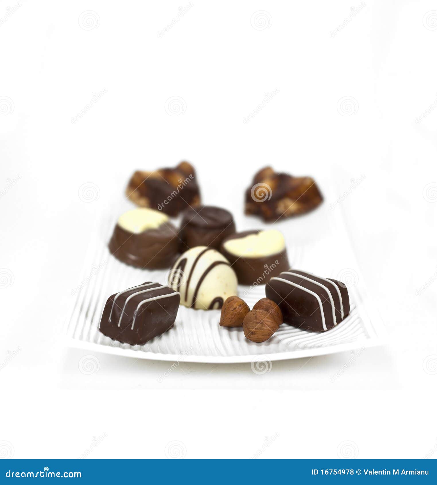 Chocolates on a White Plate Stock Photo - Image of chocolate, brown ...