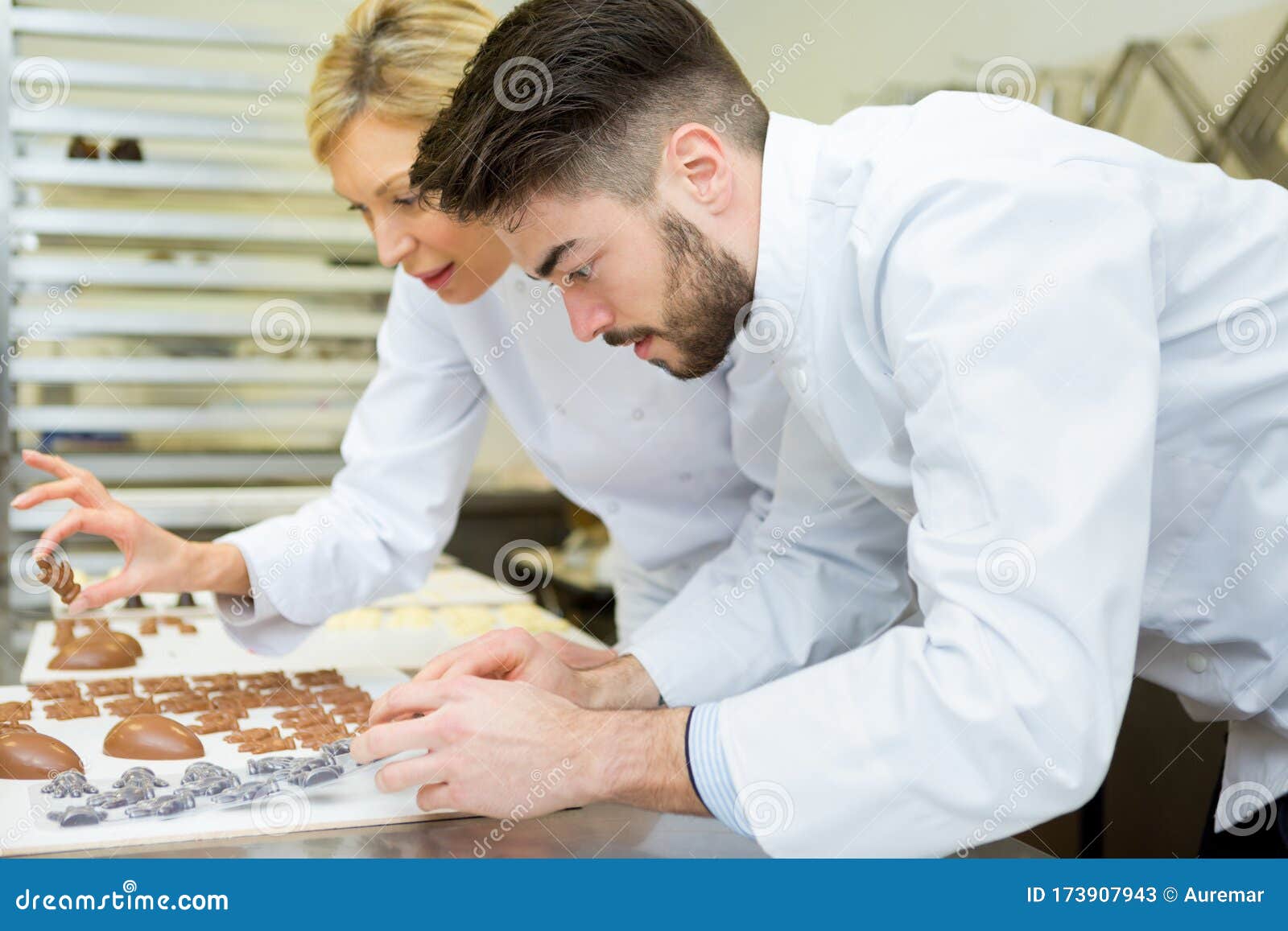 Chocolatiers at work stock image. Image of guide, chocolatier - 173907943