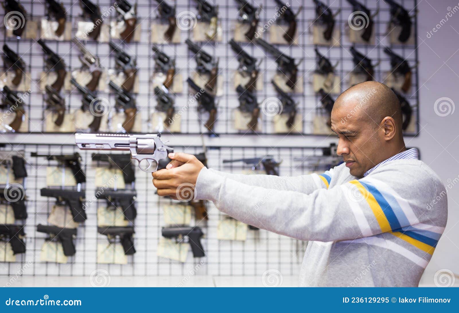 Choosing a Revolver in Gun Shop Closeup Stock Image - Image of buyer ...