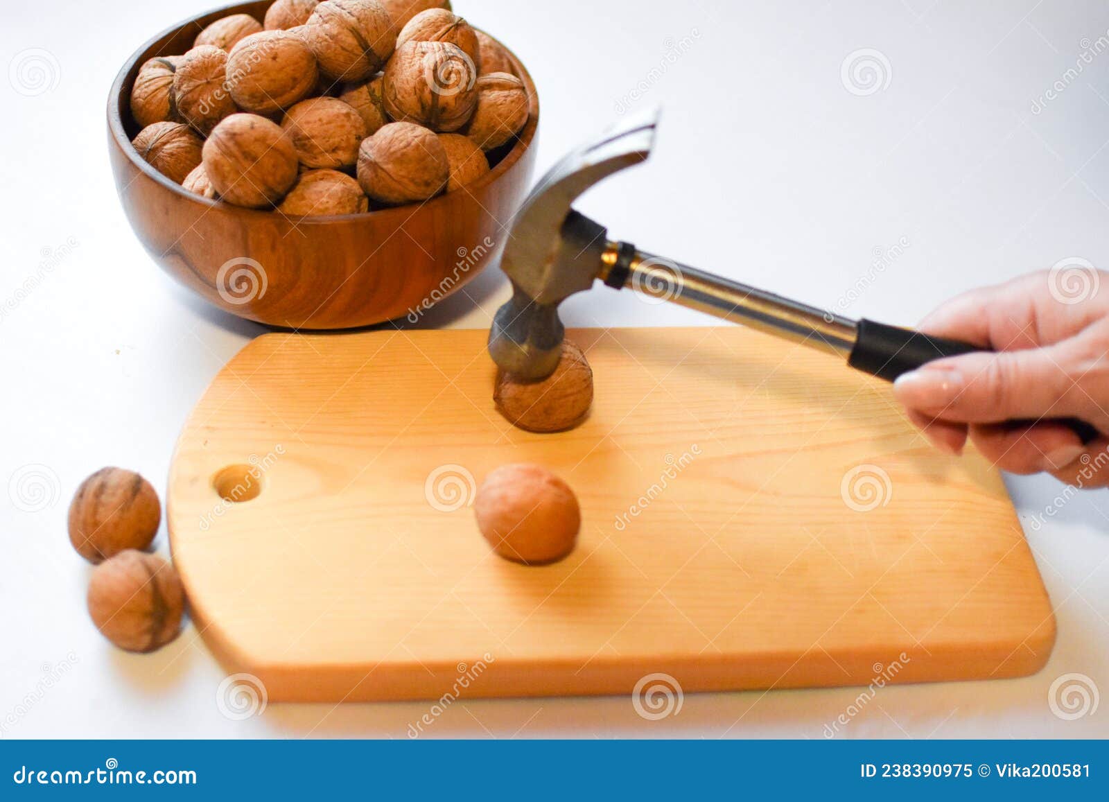 Chop Walnuts with a Hammer on a Cutting Board. Strong Natural Walnuts ...