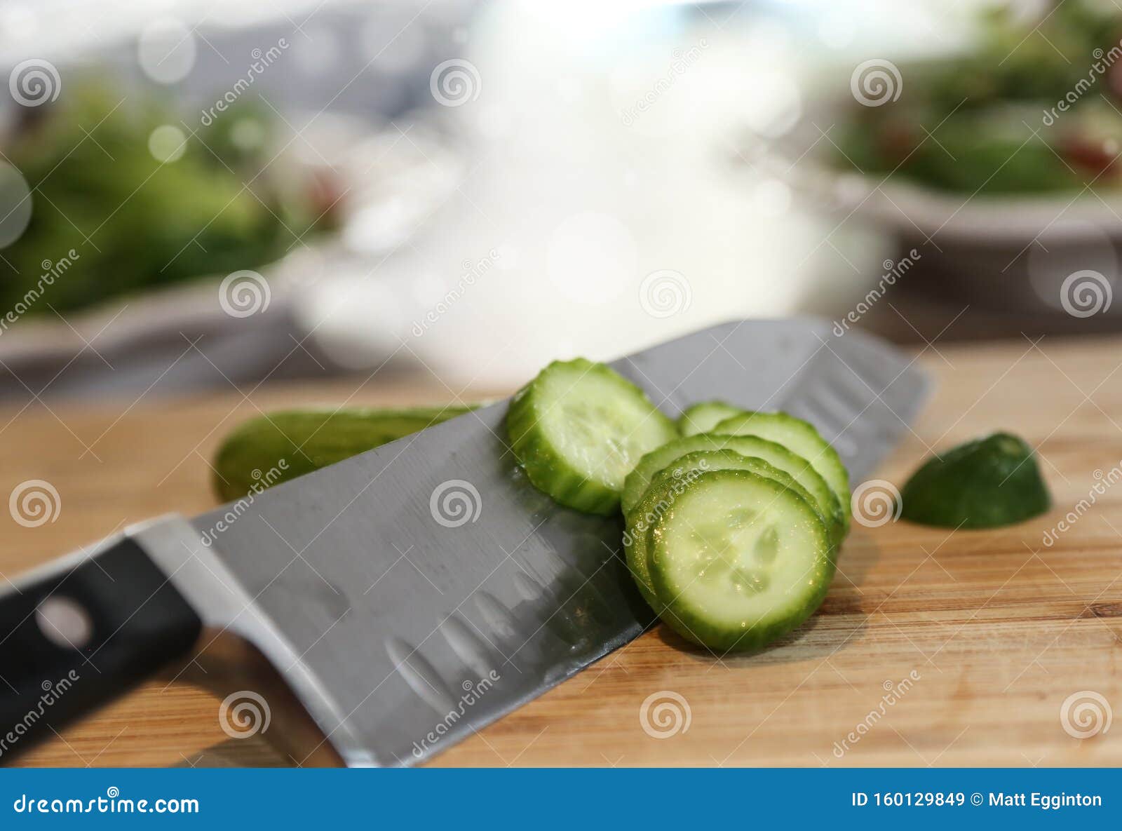 Chopping Board with a Cucumber Being Chopped. Chopped Cucumber Stock ...