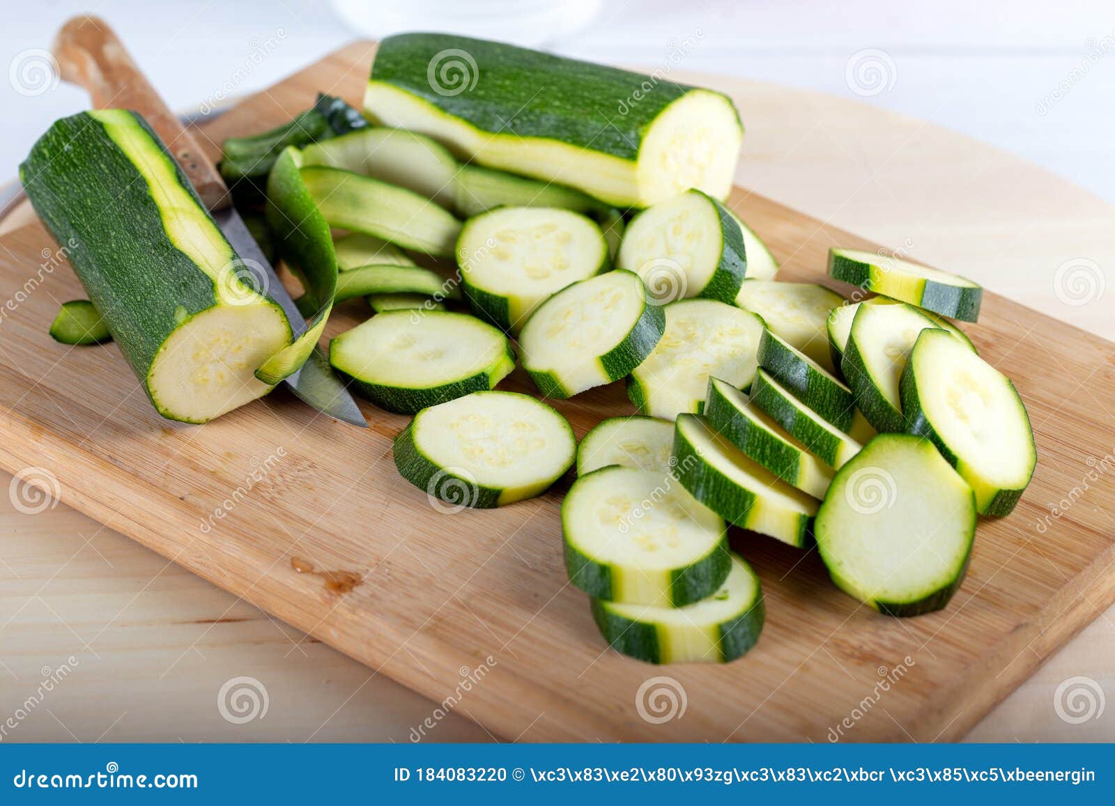 Chopping Zucchini with a Knife on a Wooden Board. Stock Photo - Image ...