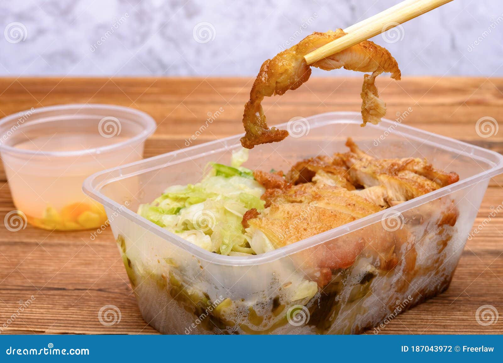 Chopstick Picking Up Piece of Deep Fried Chicken from Box of Fast Food ...