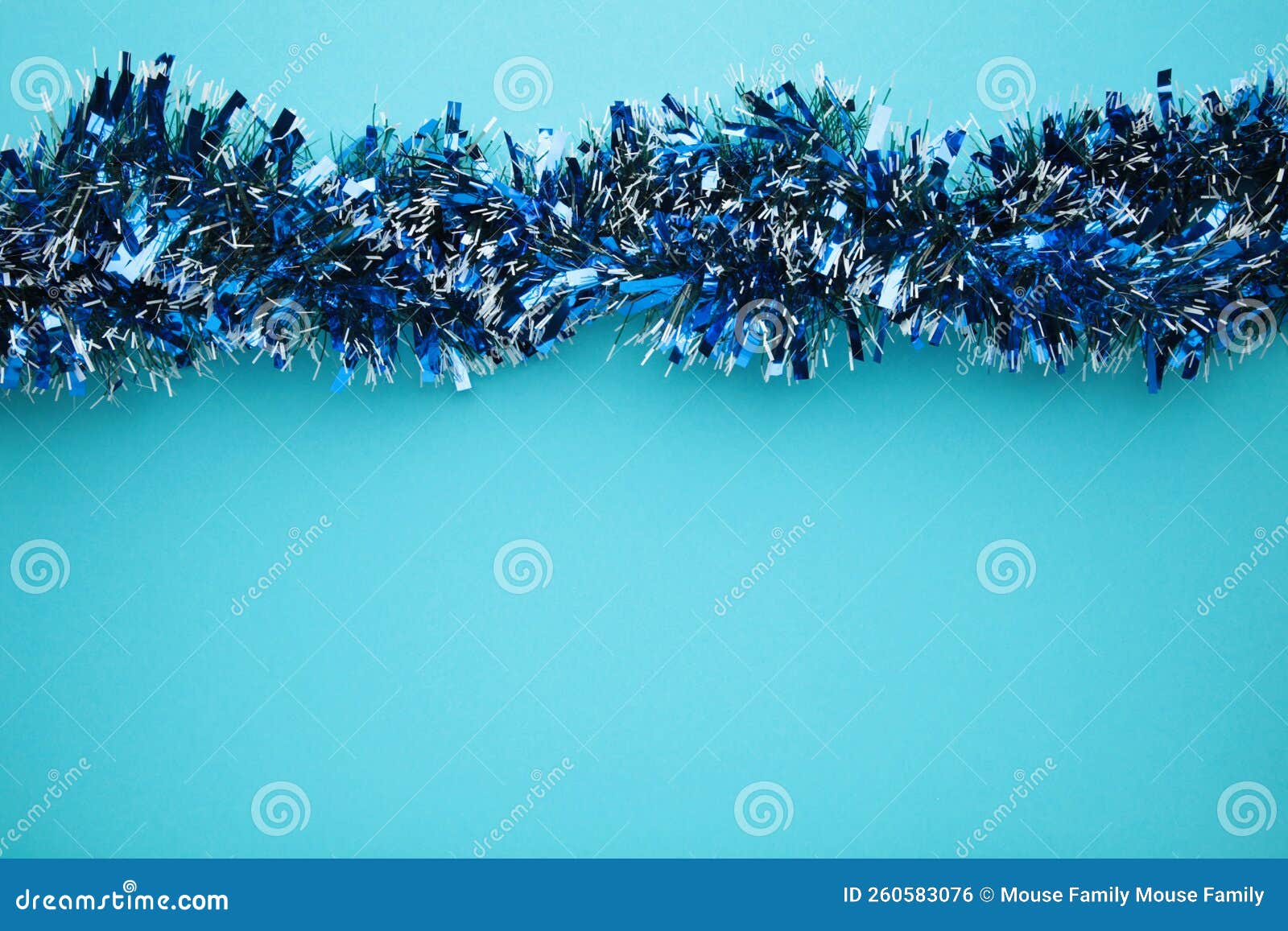 Christmas Blue Tinsel on Blue Background. Space for Text Stock Photo ...