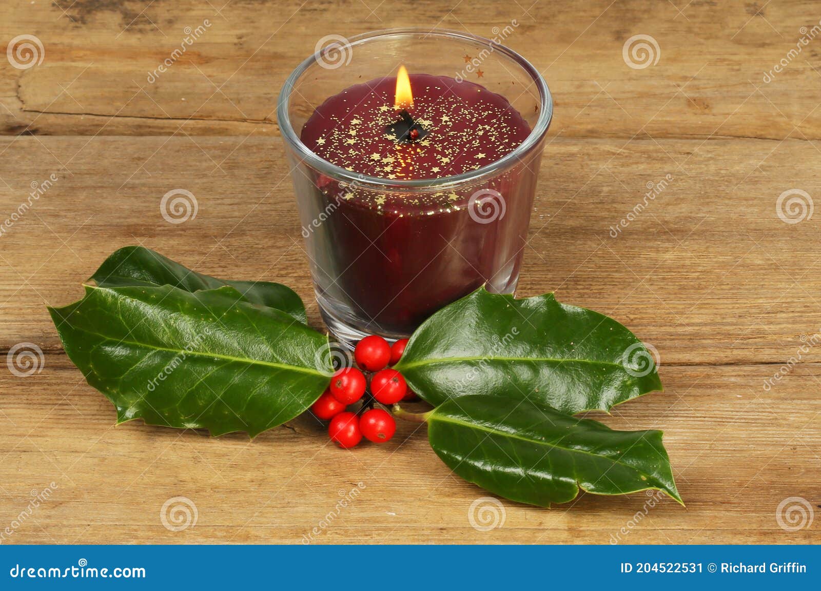 Christmas candle and holly stock image. Image of evergreen - 204522531