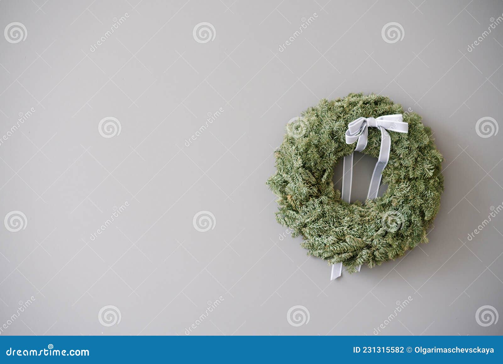 Christmas Decorative Wreath with a Gray Bow on the Background of a Gray ...