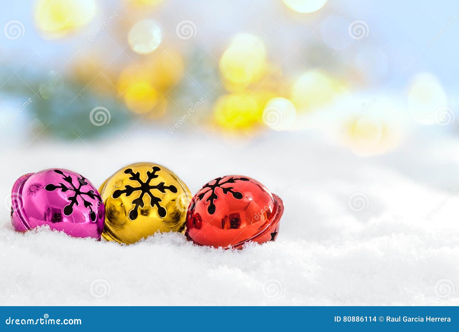 Christmas Jingle Bells in the Snow and Defocused Lights Stock Photo ...