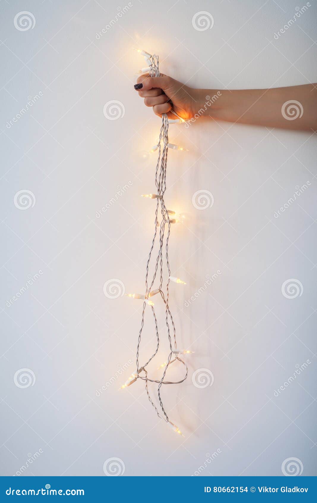 Christmas lights in hand stock photo. Image of decoration - 80662154
