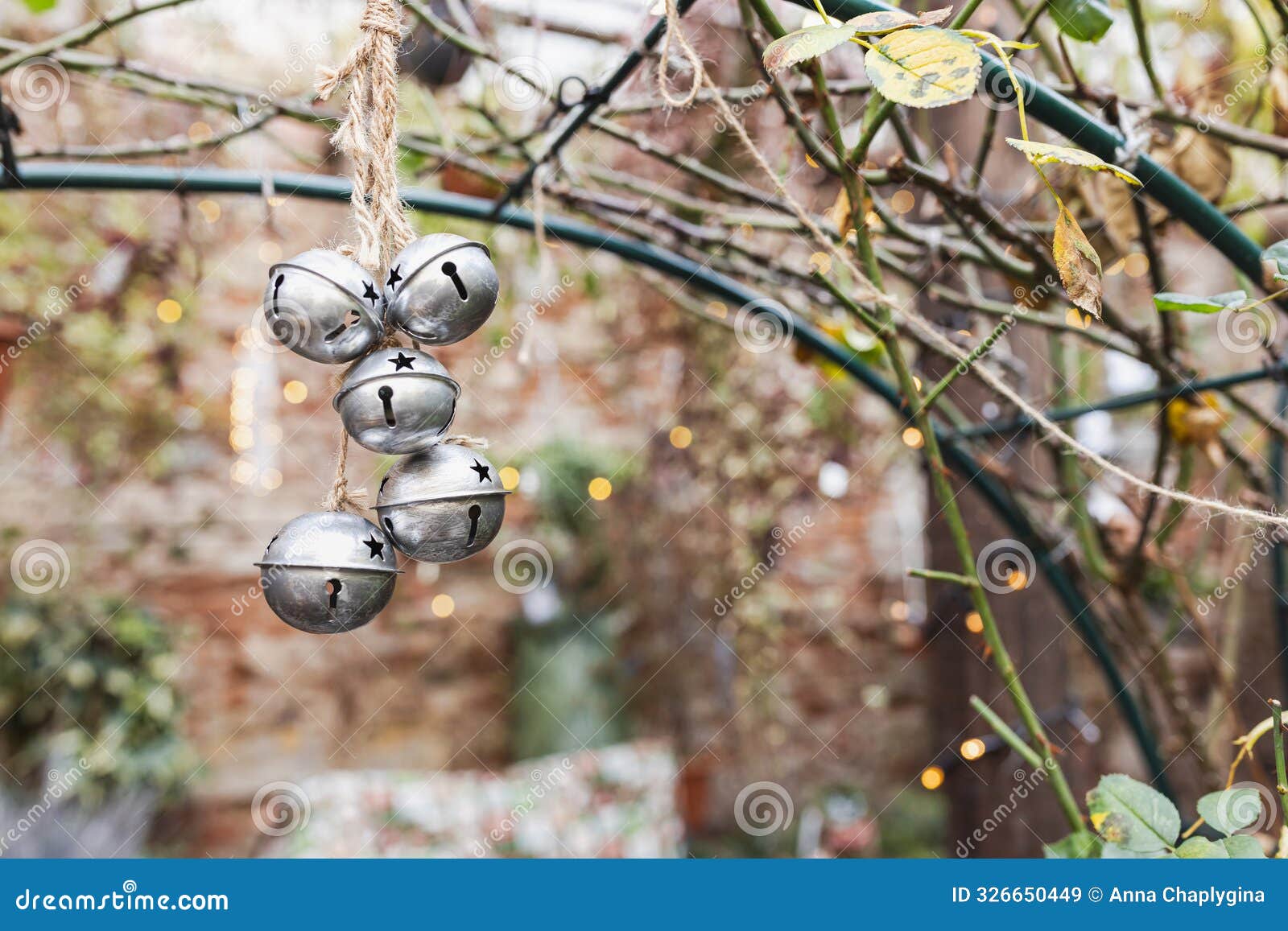 Christmas Silver Bells Hanging in a Rustic Garden Stock Image - Image ...