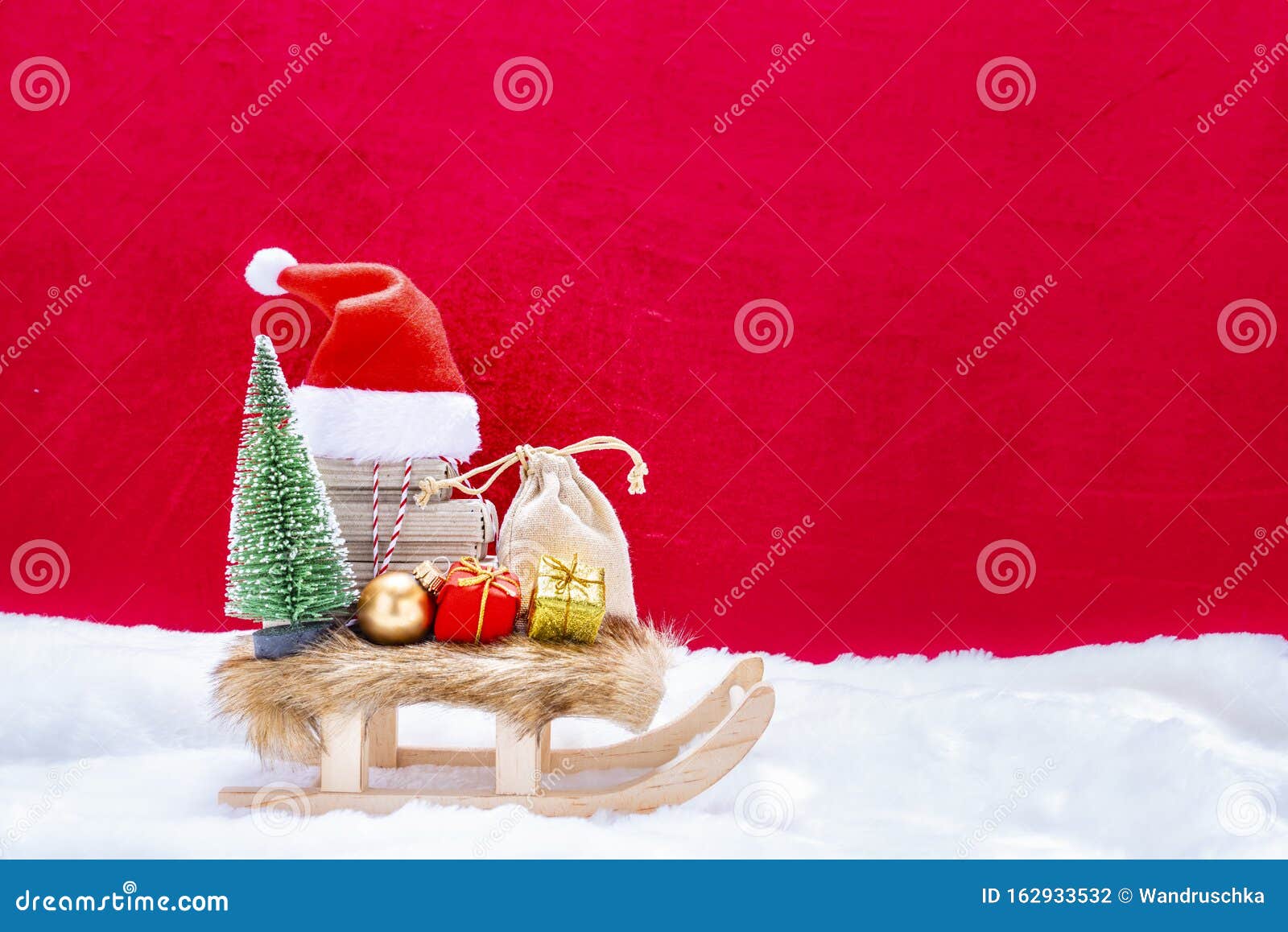 A Christmas Sledge with Presents, Santa Hat, and Fir Tree in the Snow ...