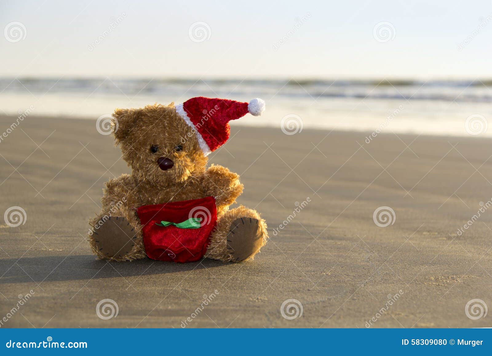 Christmas Teddy Bear Sits on the Beach. Goa, India Stock Photo - Image ...