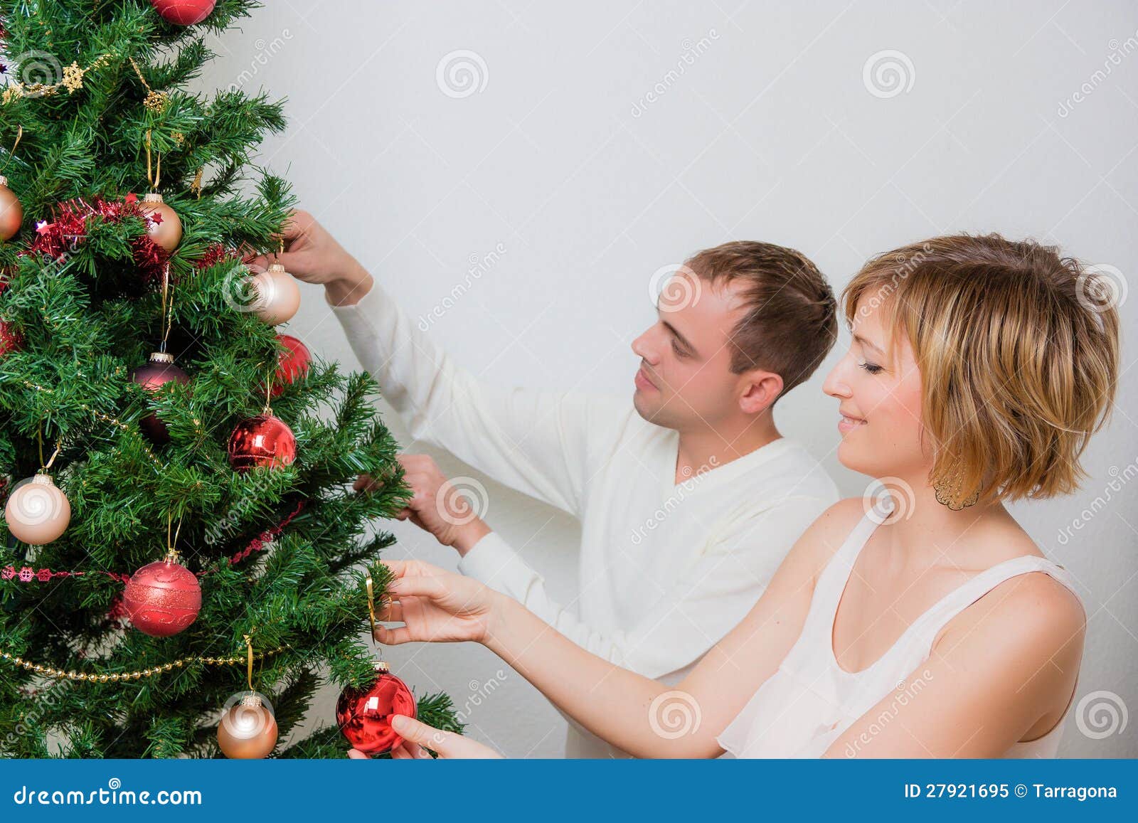 Christmas tree couple stock image. Image of gift, holiday - 27921695
