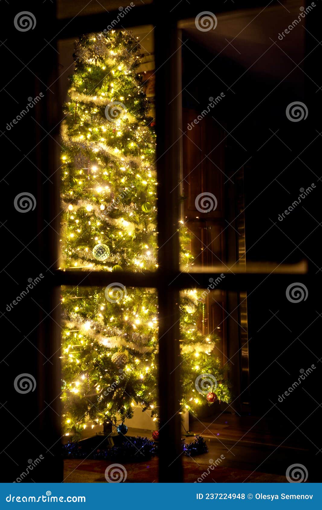 Christmas Tree with Defocused Lights through a Window Stock Photo ...
