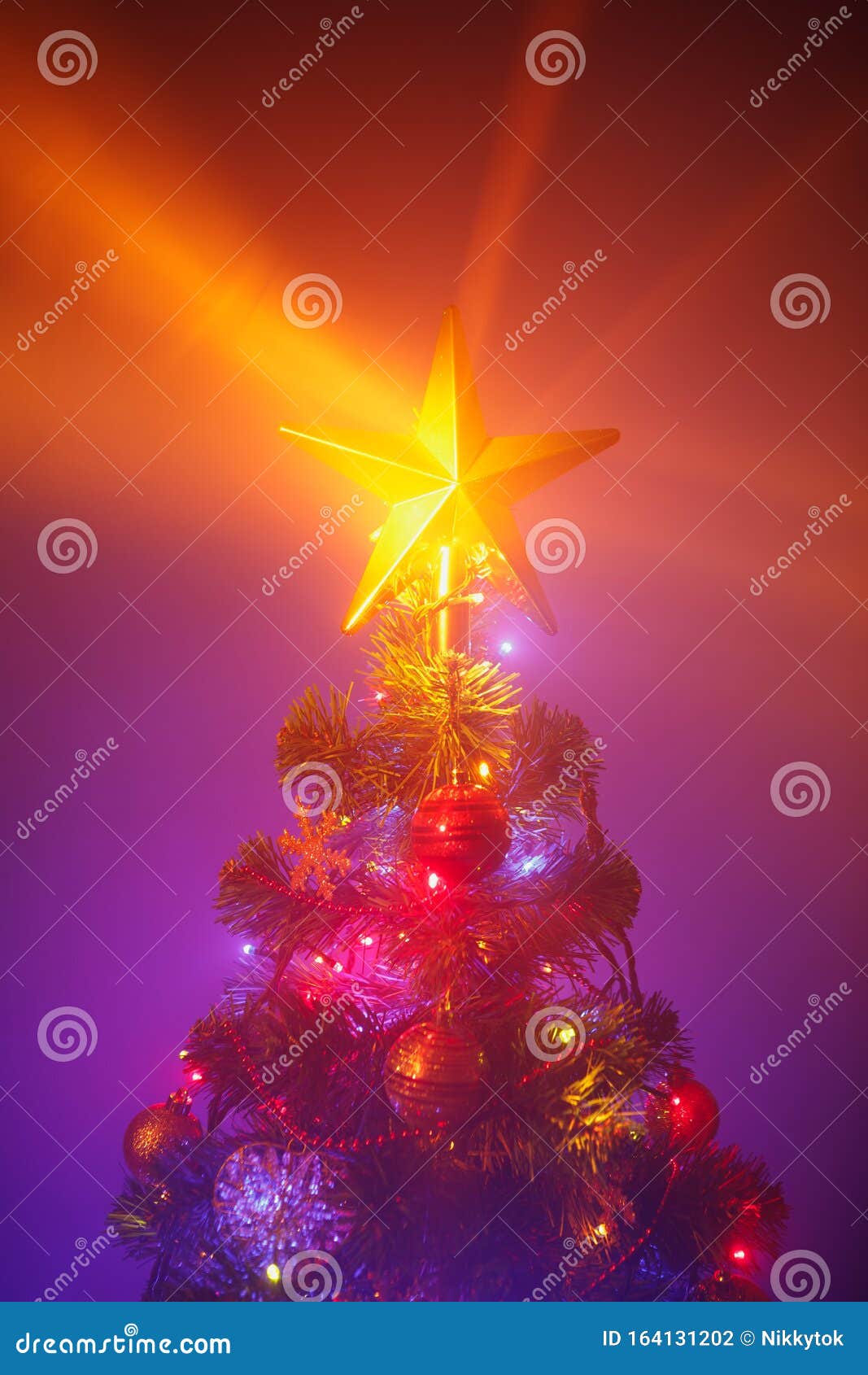 Christmas Tree with Festive Lights, Purple Background with Mist Stock ...