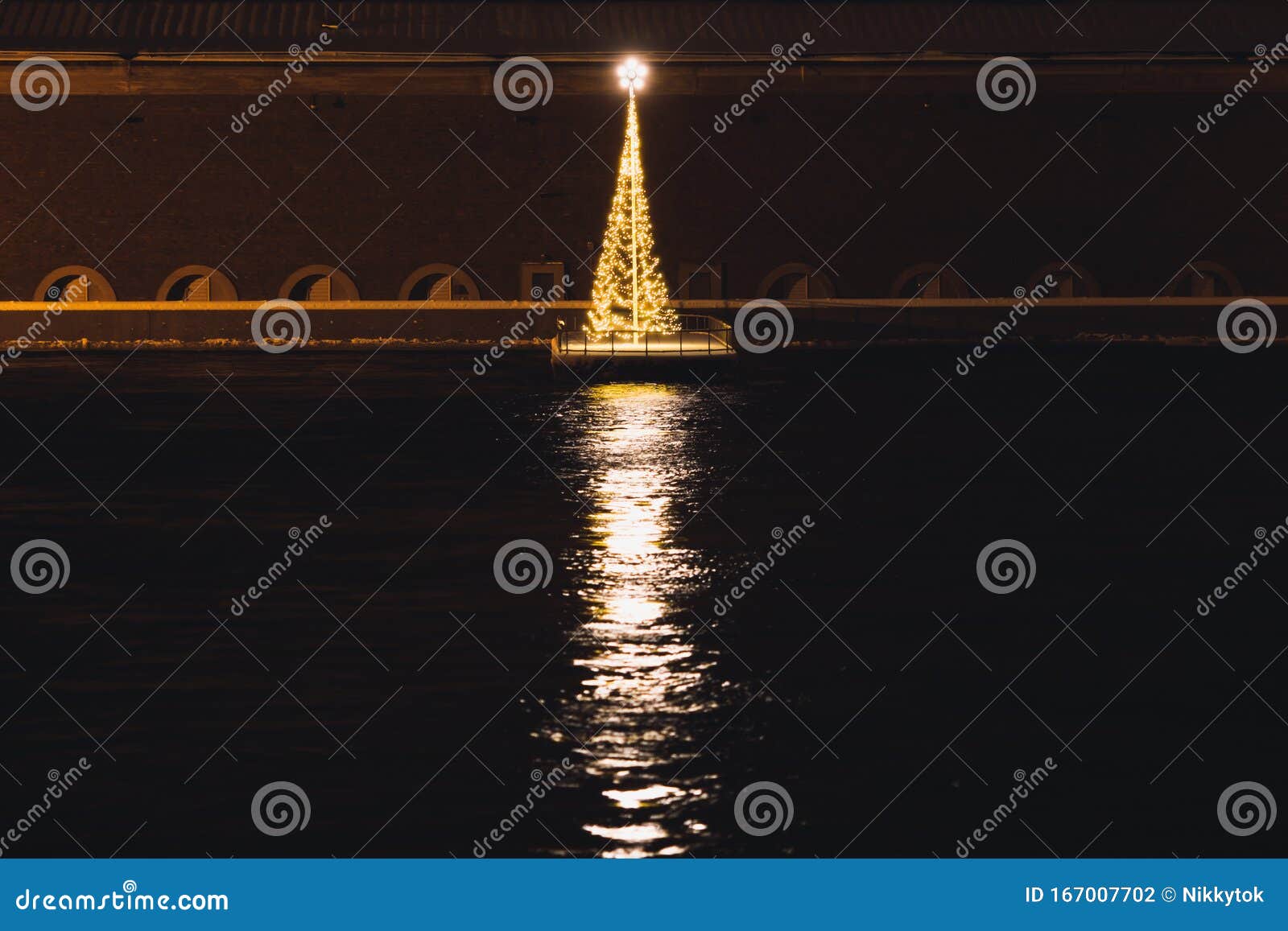 Christmas Tree Floating on the Water with Lights Reflection Stock Photo ...