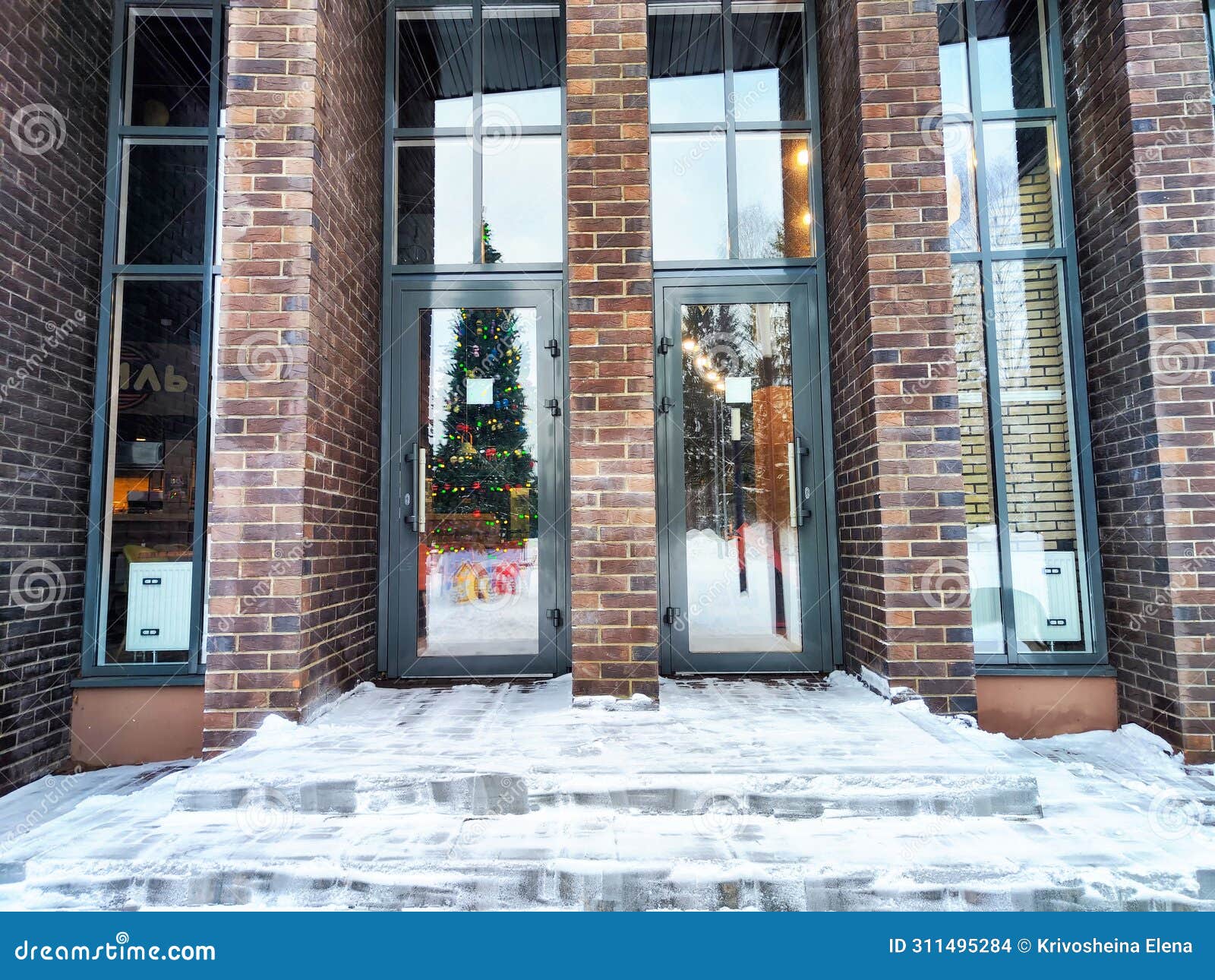 Christmas Tree through Window of Snow Covered Storefront with Brick ...