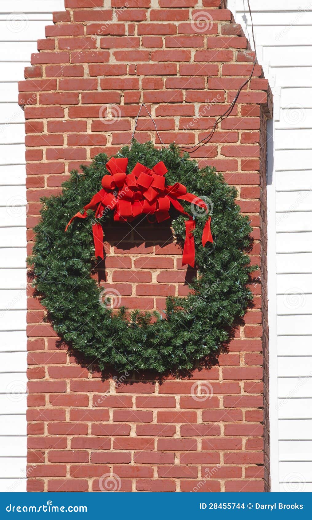 Christmas Wreath with Red Ribbon on Brick Chimney Stock Photo - Image ...