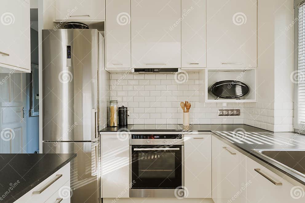 Chrome Fridge in White Kitchen Stock Photo - Image of design, cupboard ...