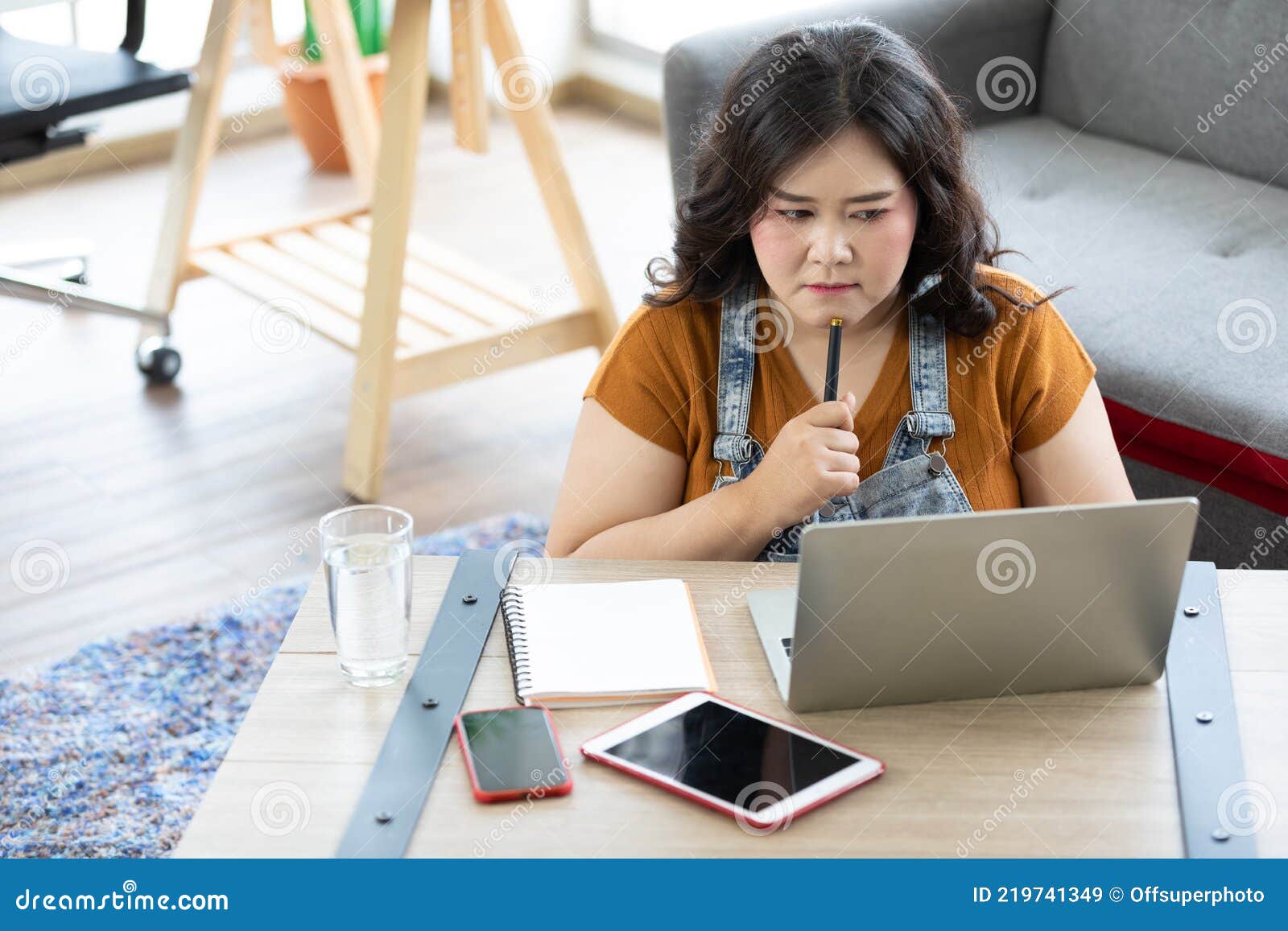 Chubby Woman Looking at Laptop Computer and Thinking about Work or ...