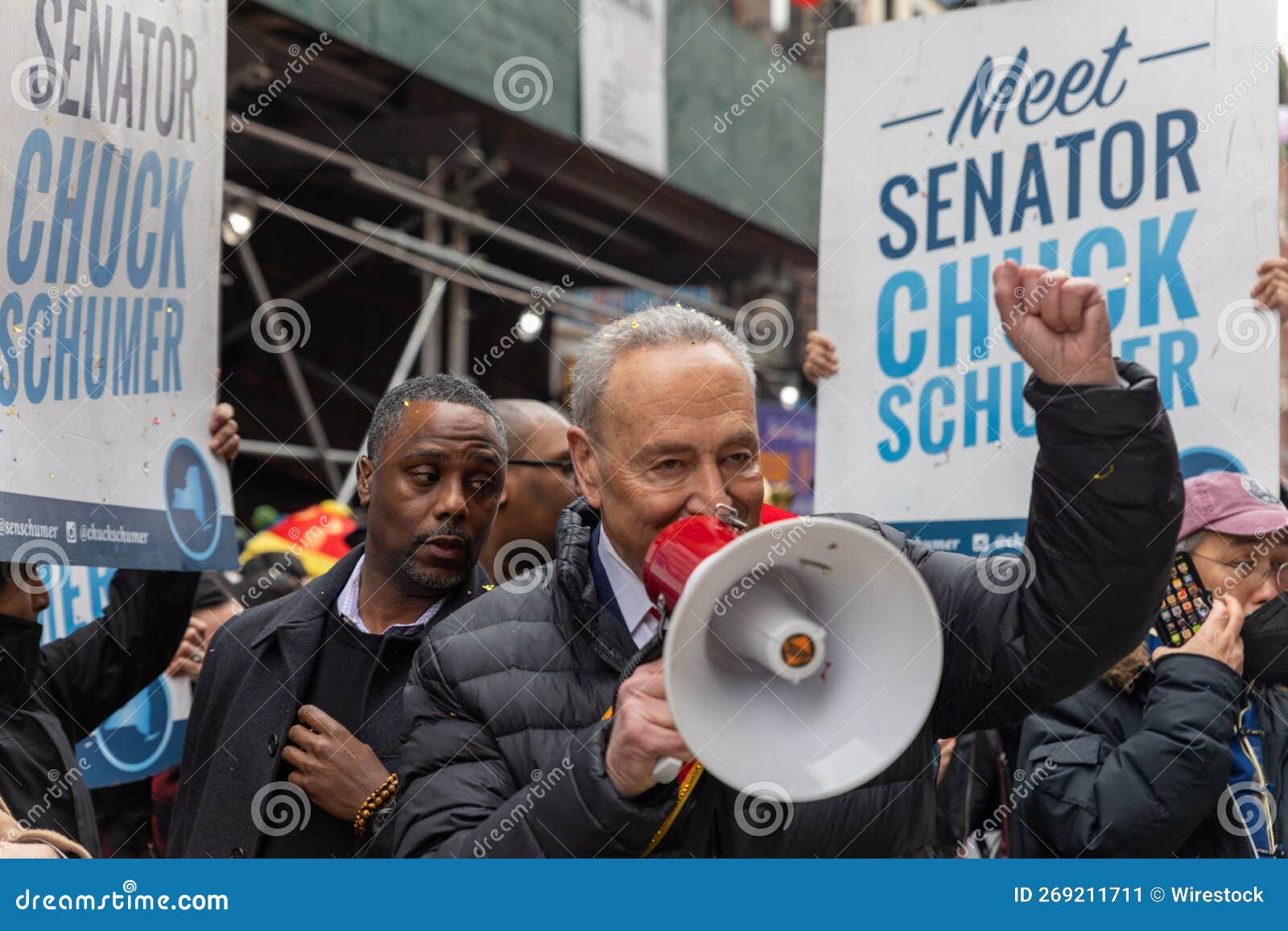 Chuck Schumer Standing in Front of a Crowd, Raising a Megaphone and ...