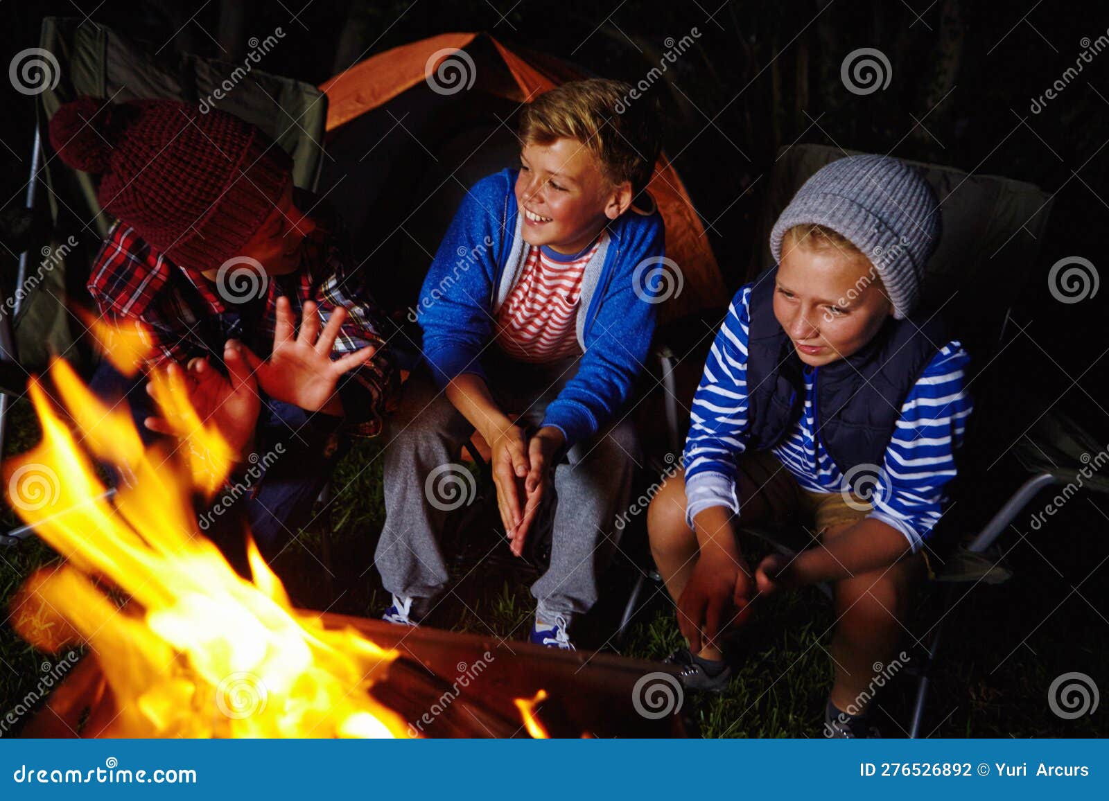 Chums Around the Campfire. Three Young Boys Sitting by the Campfire ...