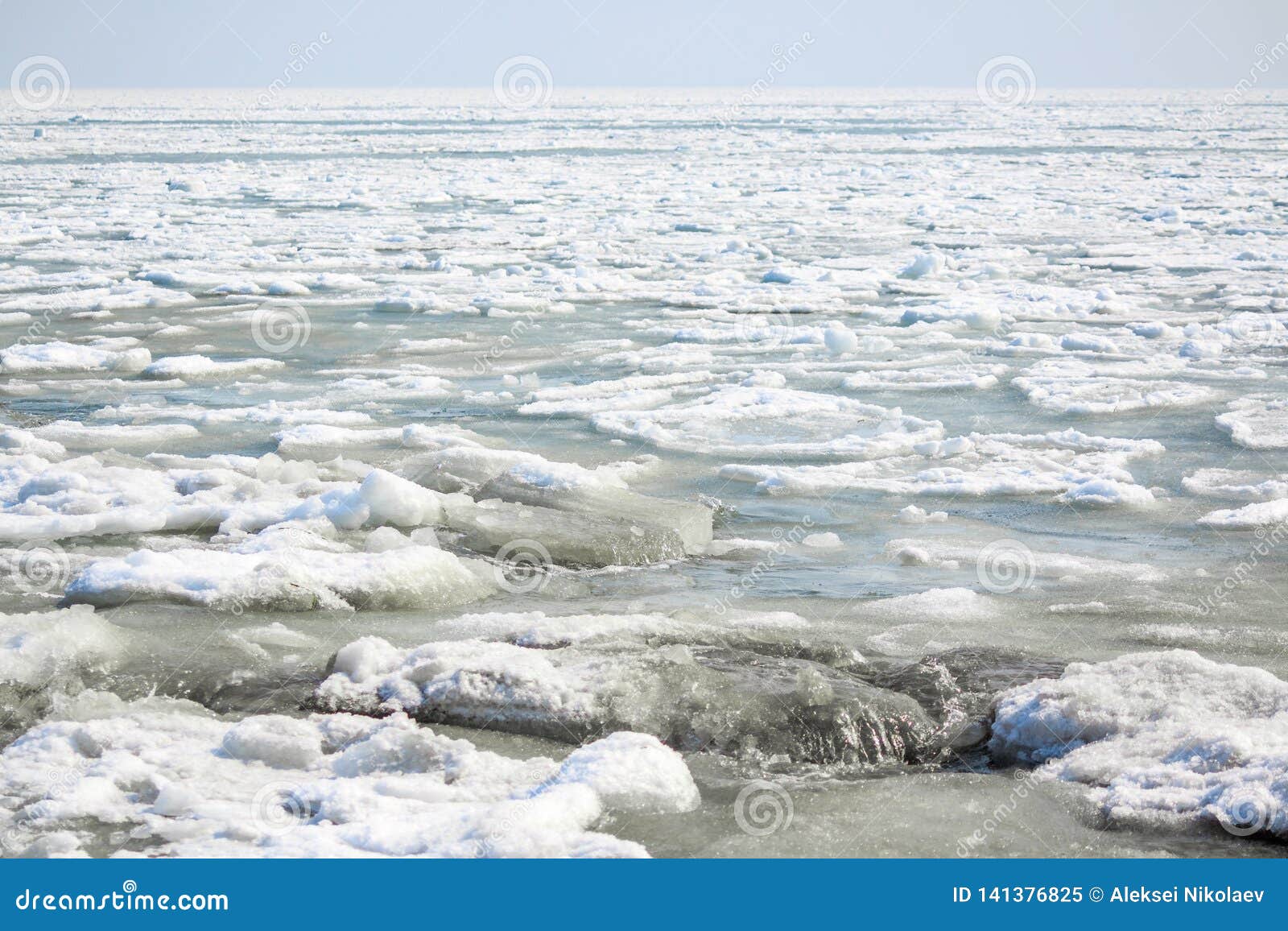 Chunks of Ice Float and Melt in a River or Lake As a Backdrop To the ...