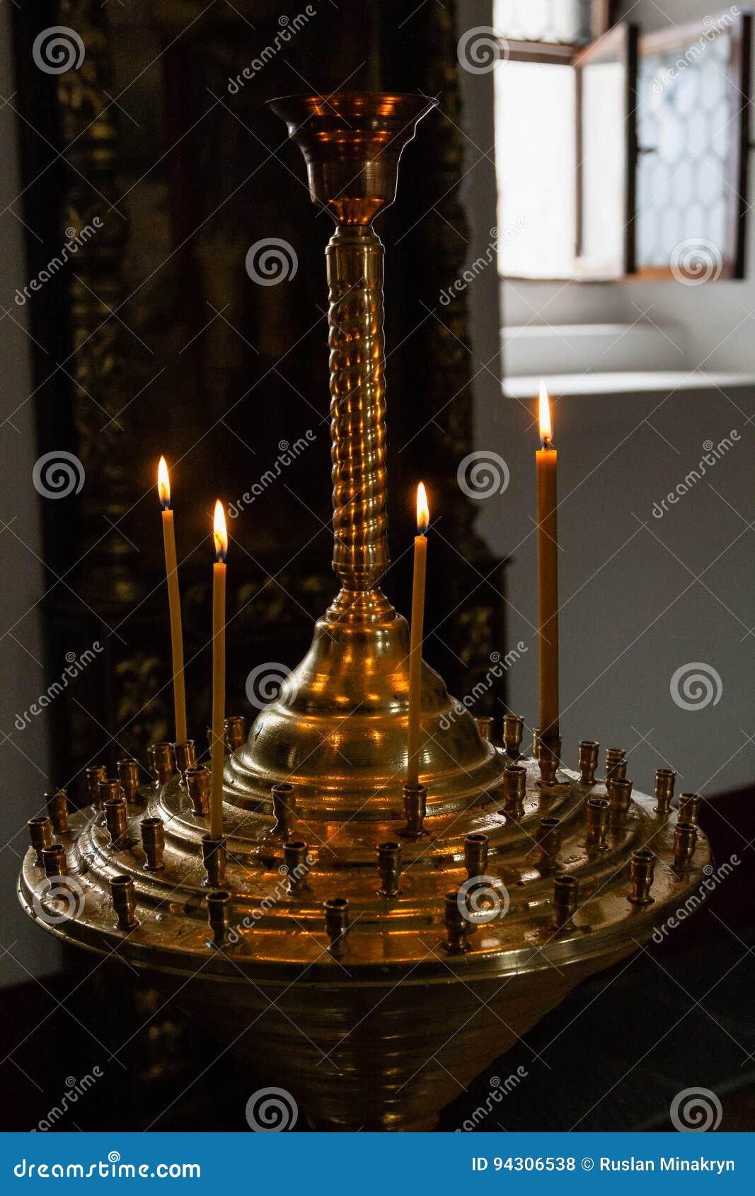 Church Candles Burn in a Candlestick Against the Backdrop of Icons ...